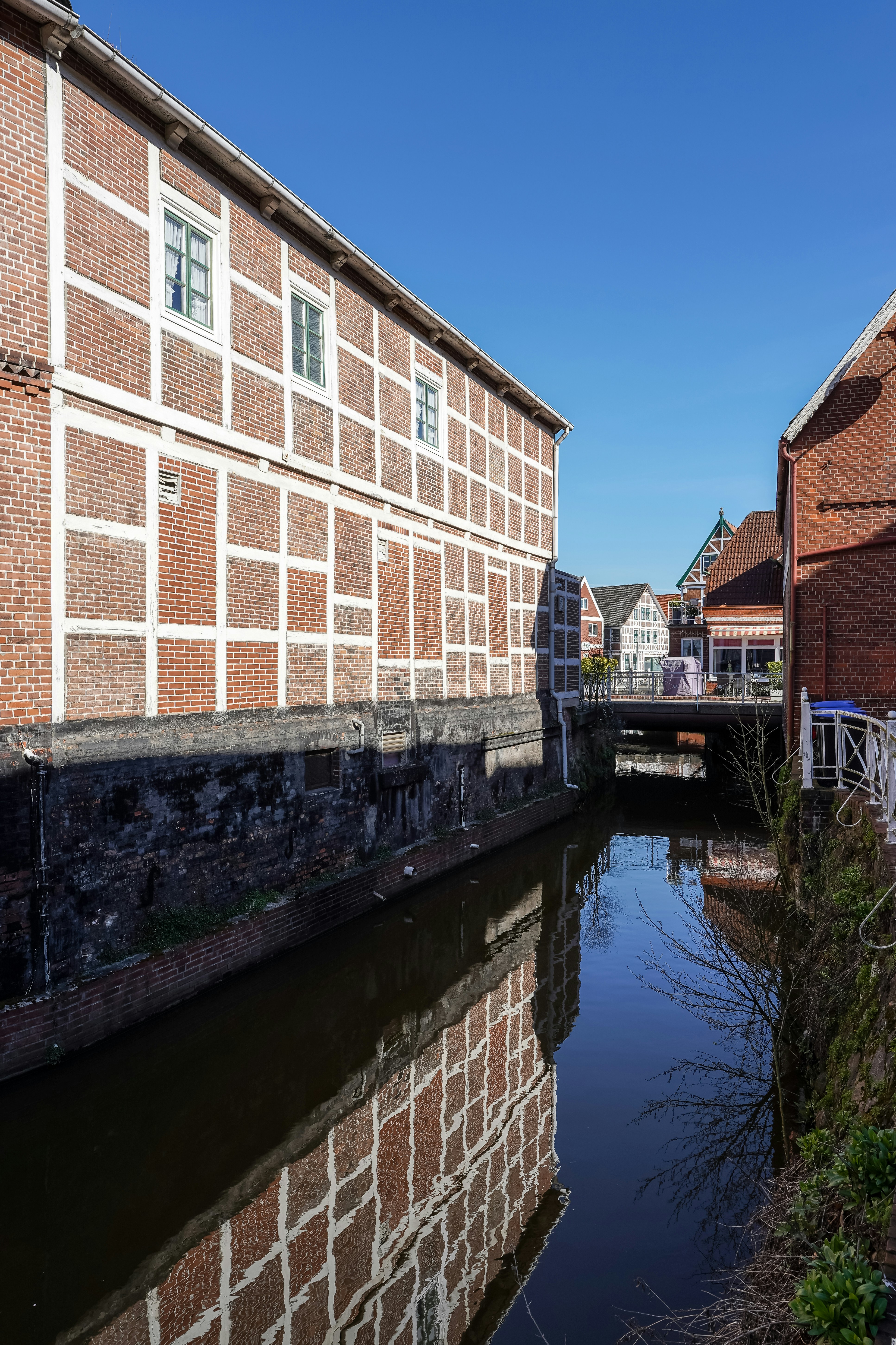 Reflections of a Brick Town along a Quiet Canal