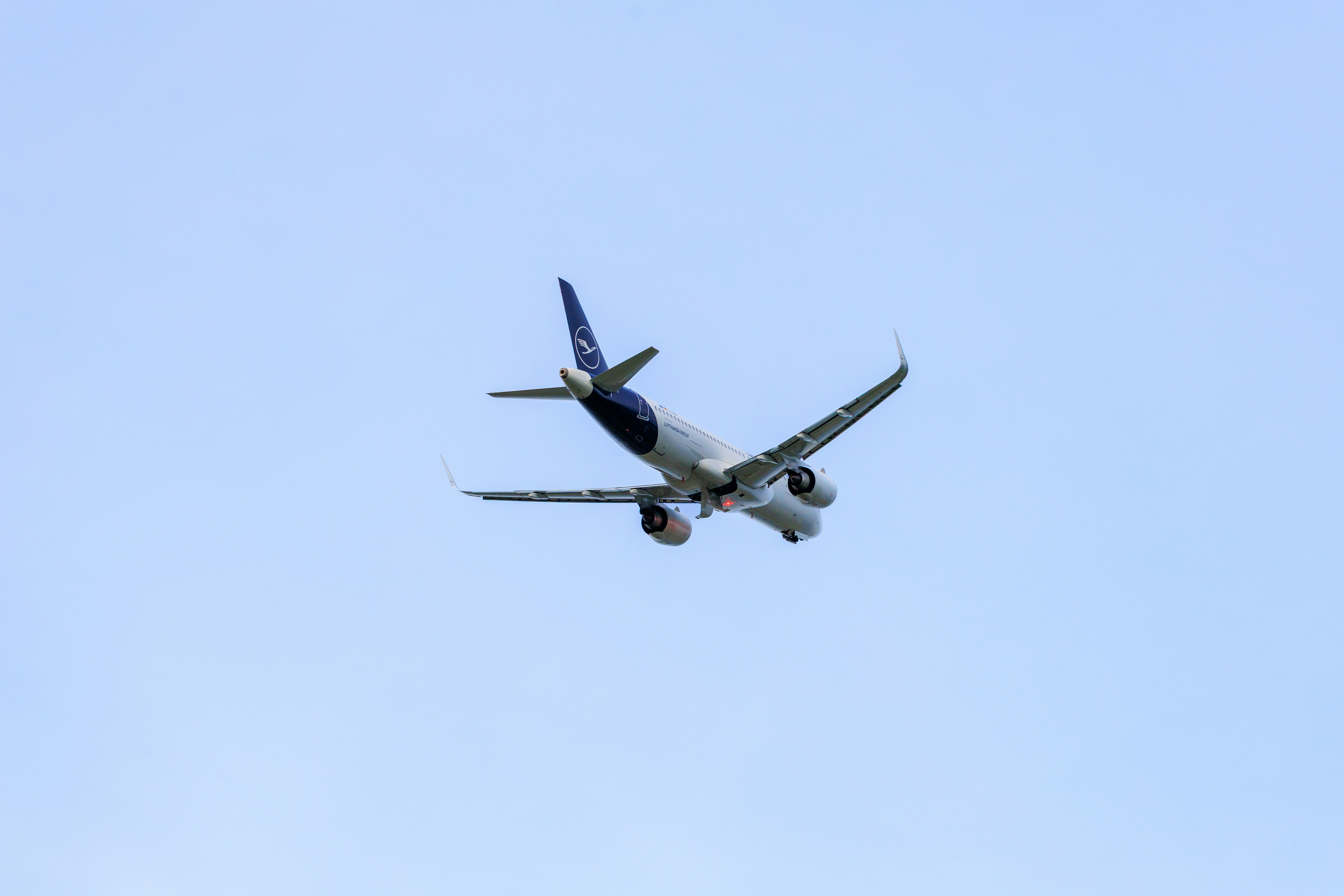 Airliner in clear blue: a banking ascent after takeoff