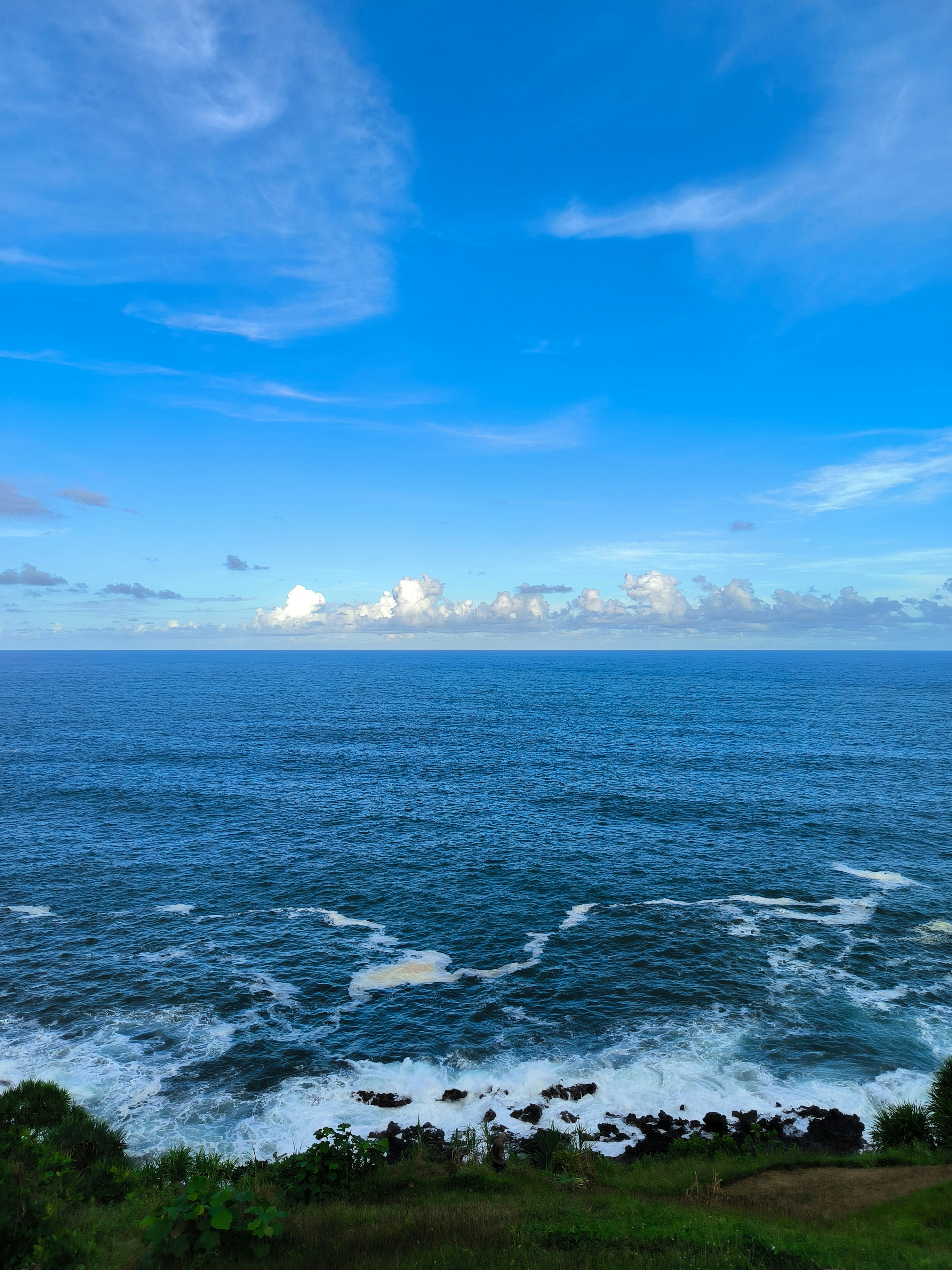 Endless Blue Horizon Over Crashing Coastal Rocks