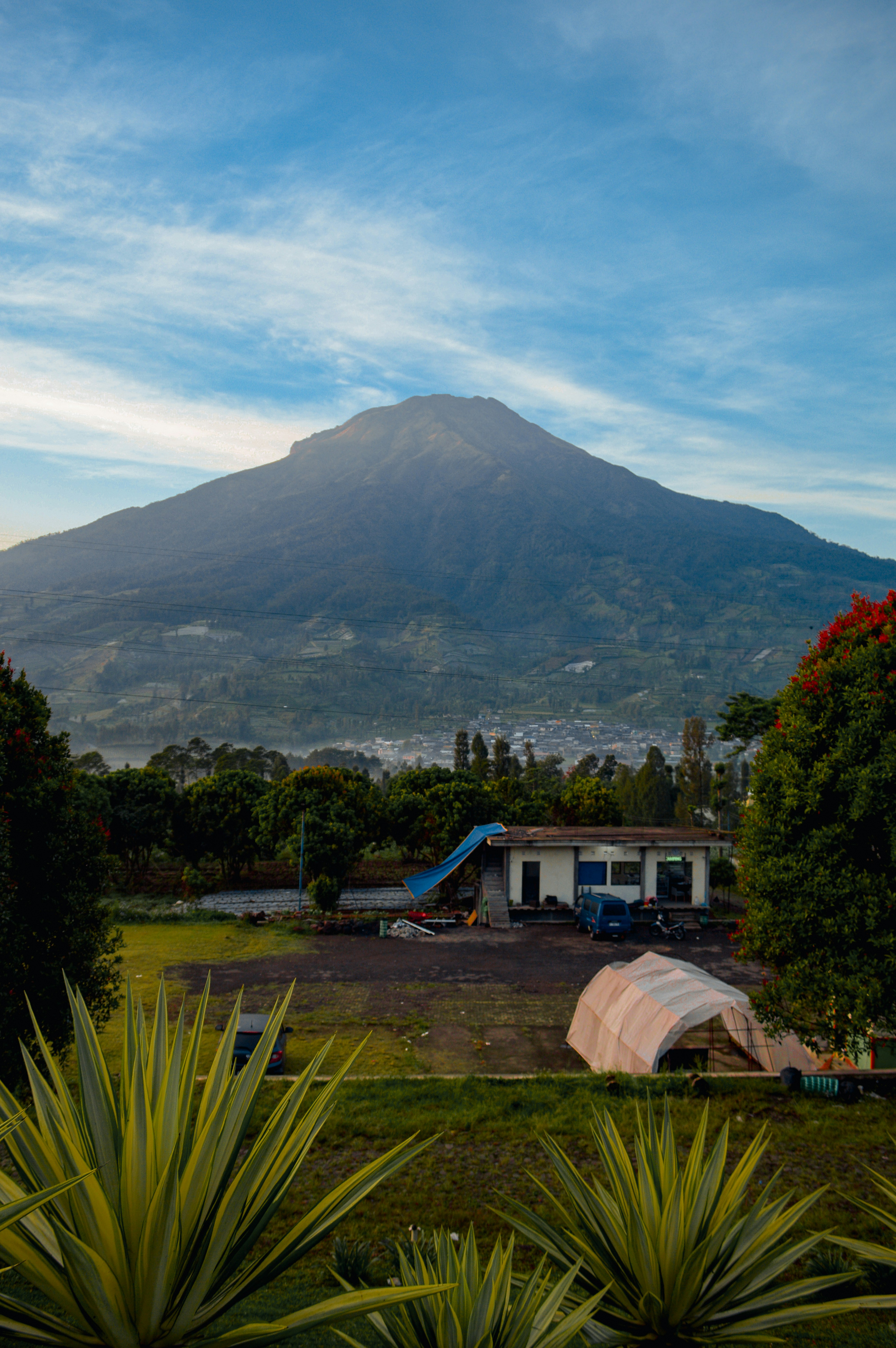 Volcanic silhouette over a tranquil fieldscape