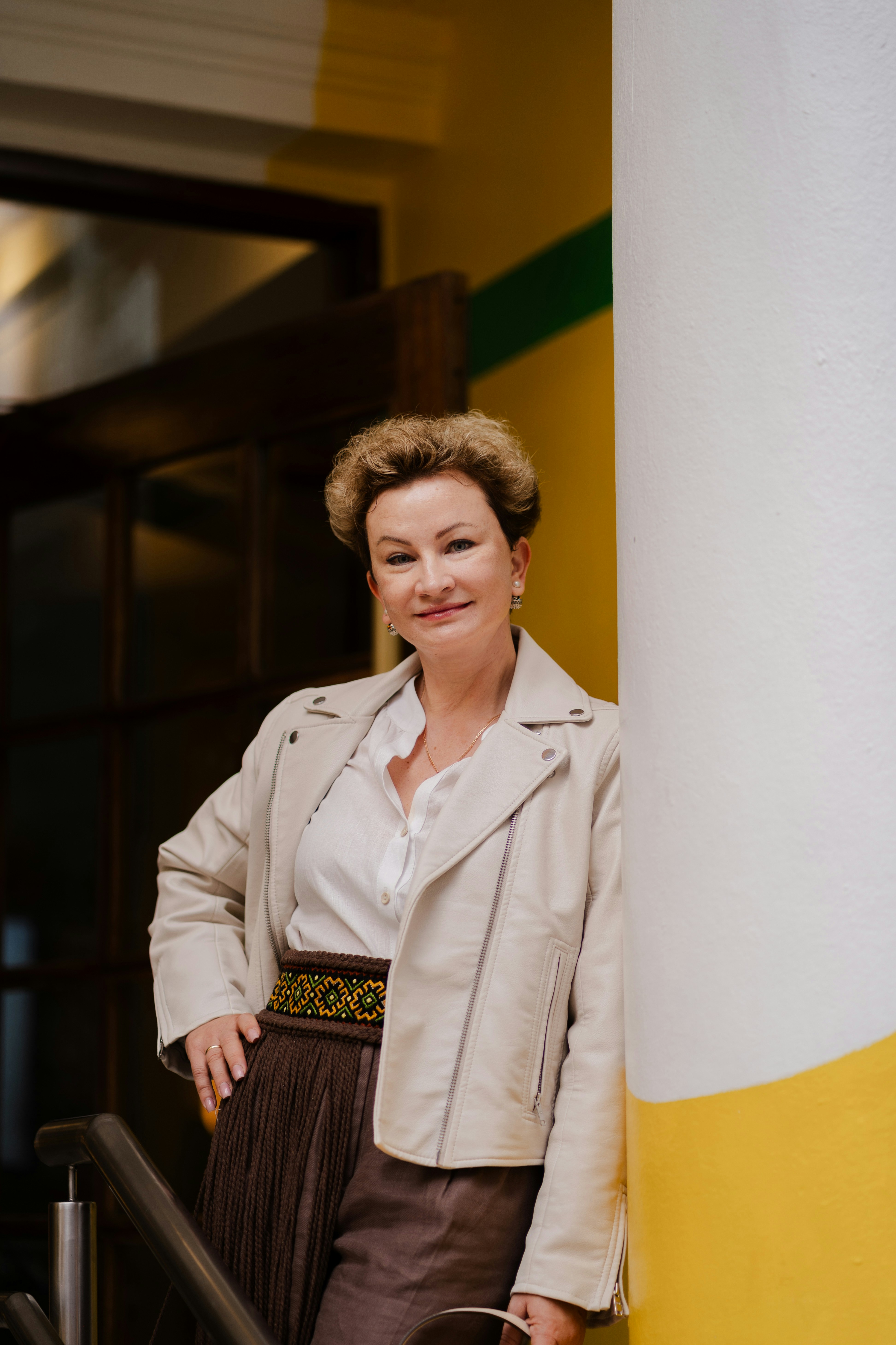 Portrait by the Column: Confidence Beside Bold Yellow and Green