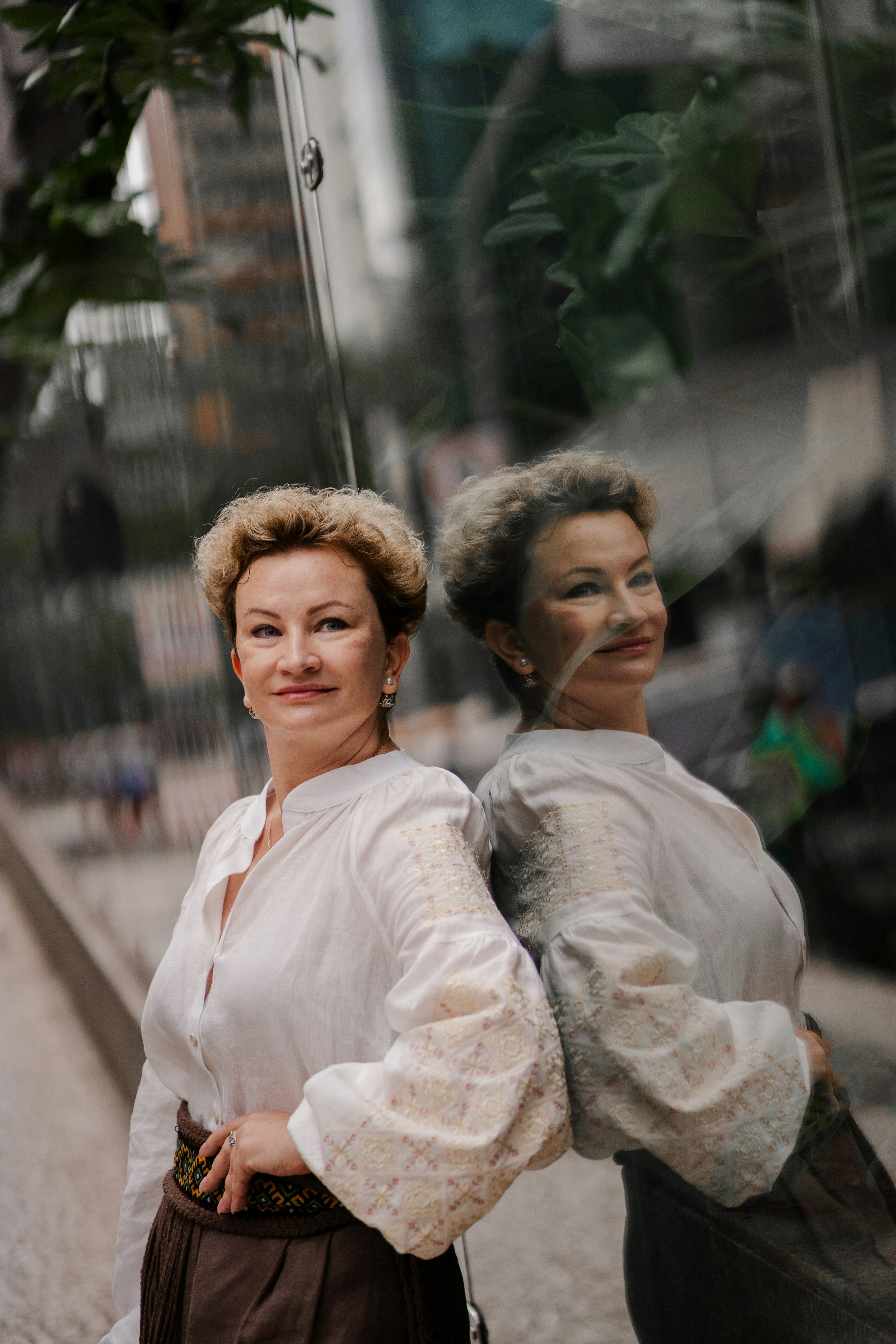 Portrait by the Glass: A Confident Smile with a Reflective Overlay