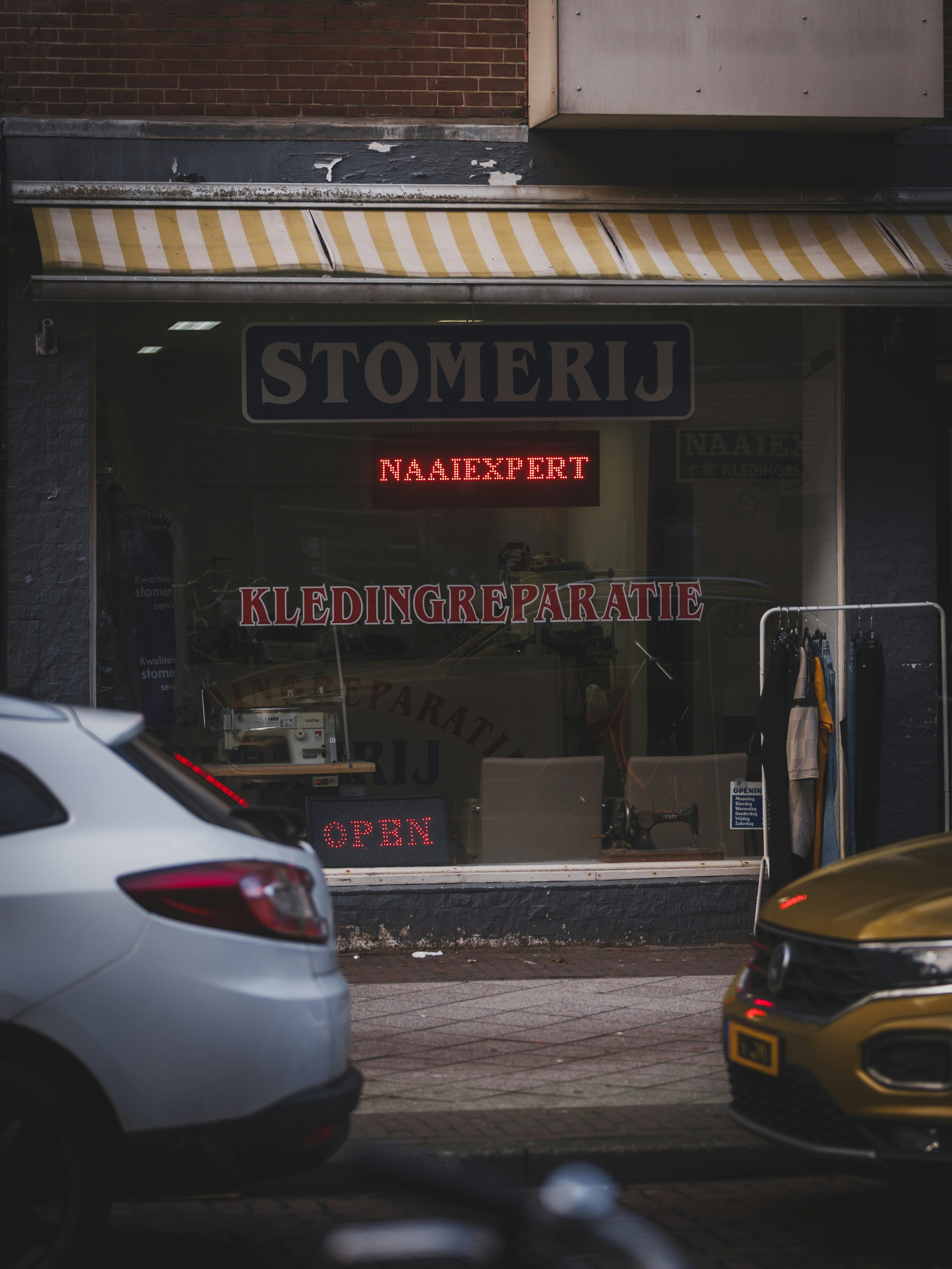 Shopfront Signage and Neon Glow Below the striped Awning