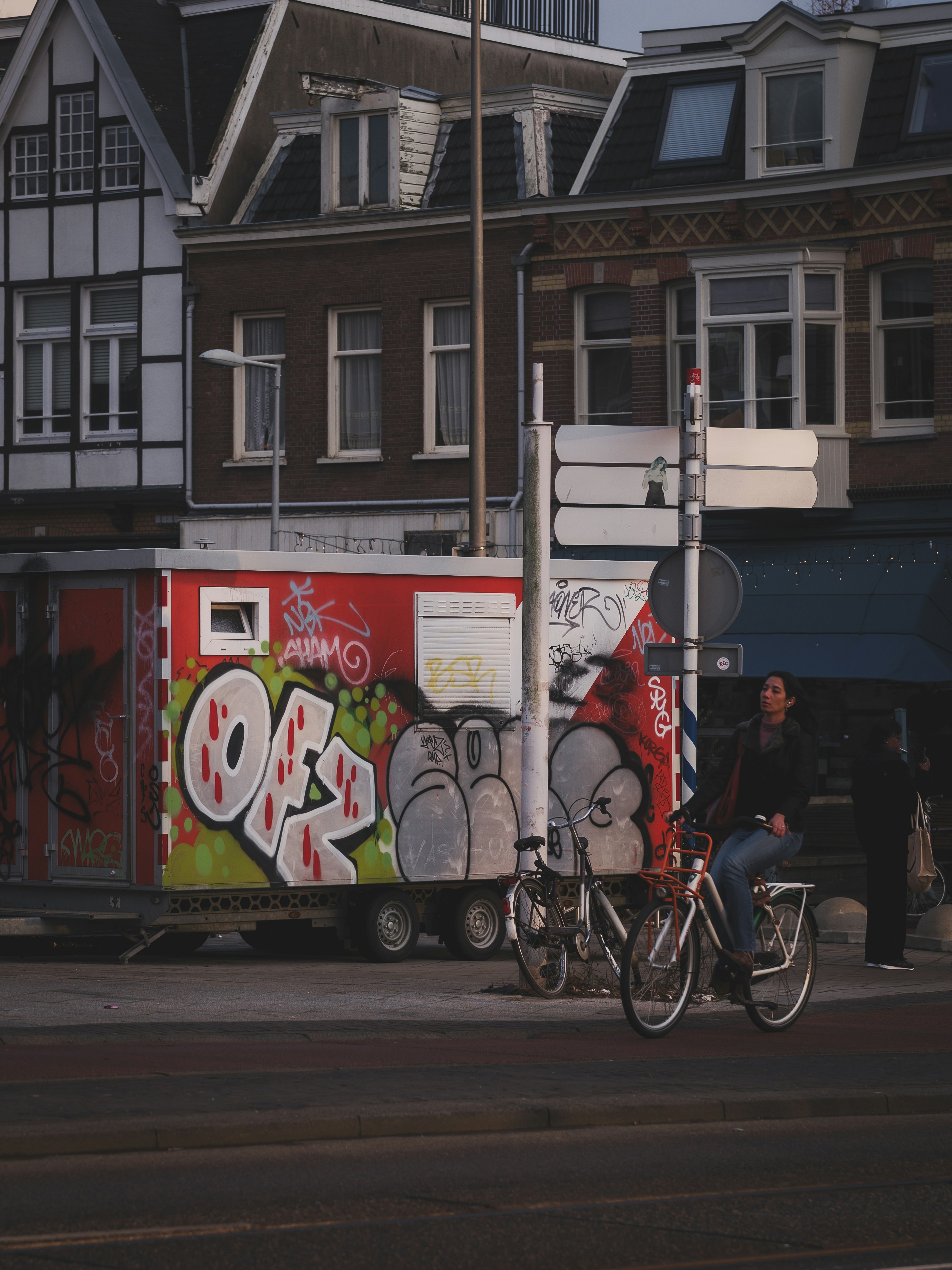 Graffiti Cart and Cyclist at a City Corner