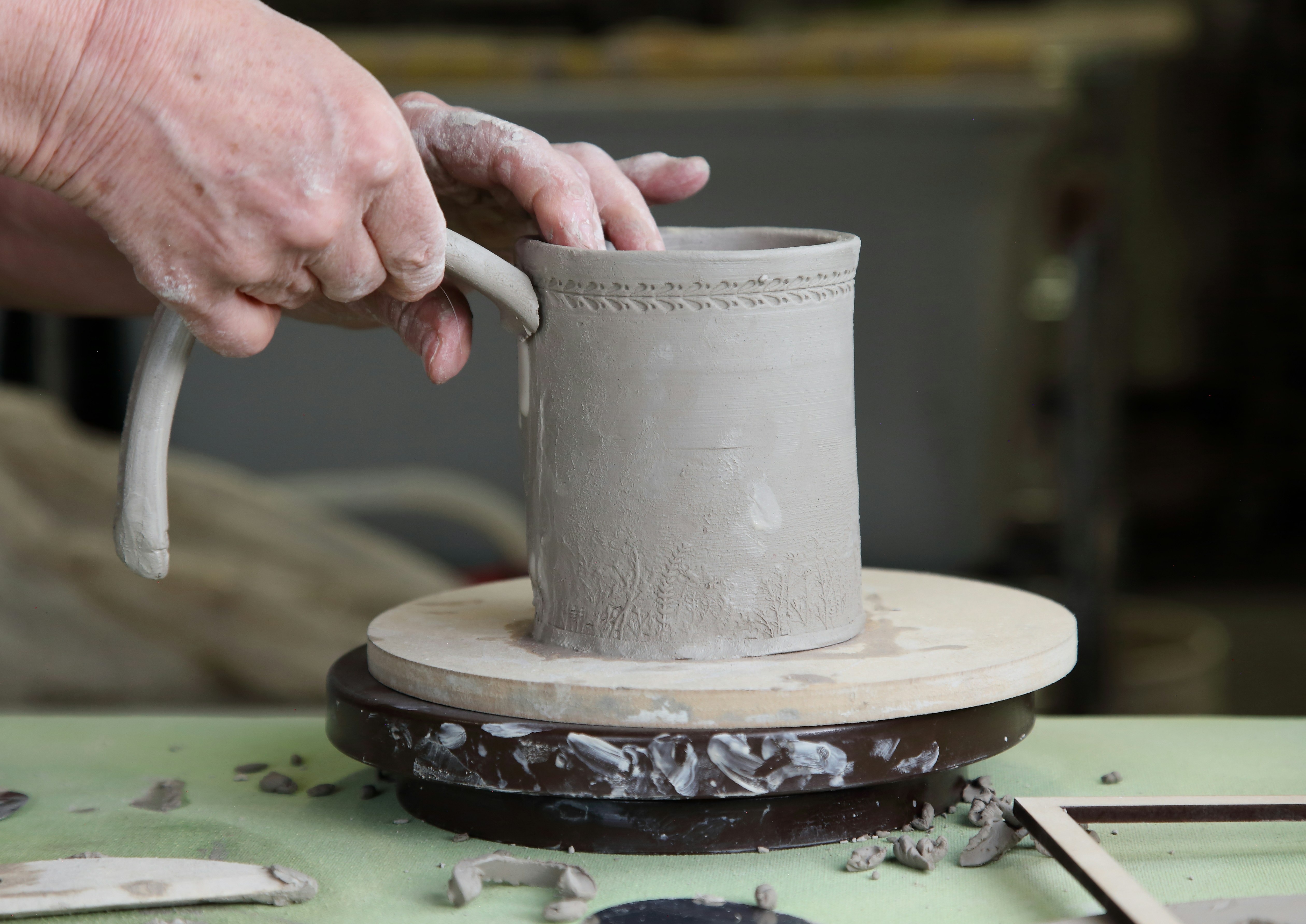 Ceramic Vessel in the Potter's Studio: A Handcrafted Handle Takes Shape
