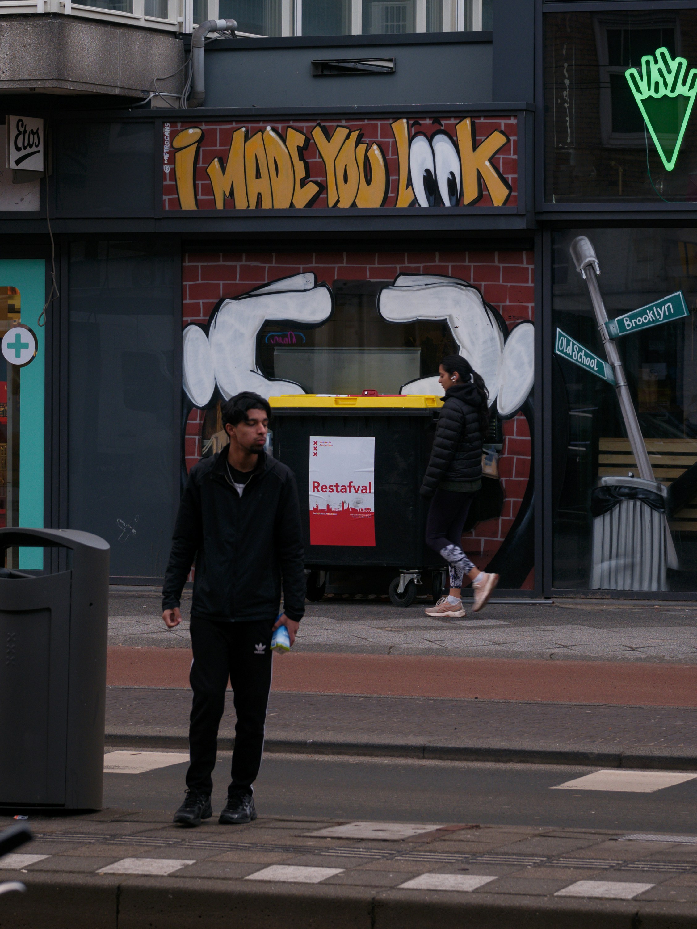 Urban Ghosts: A Street Scene Framed by Graffiti and Passersby