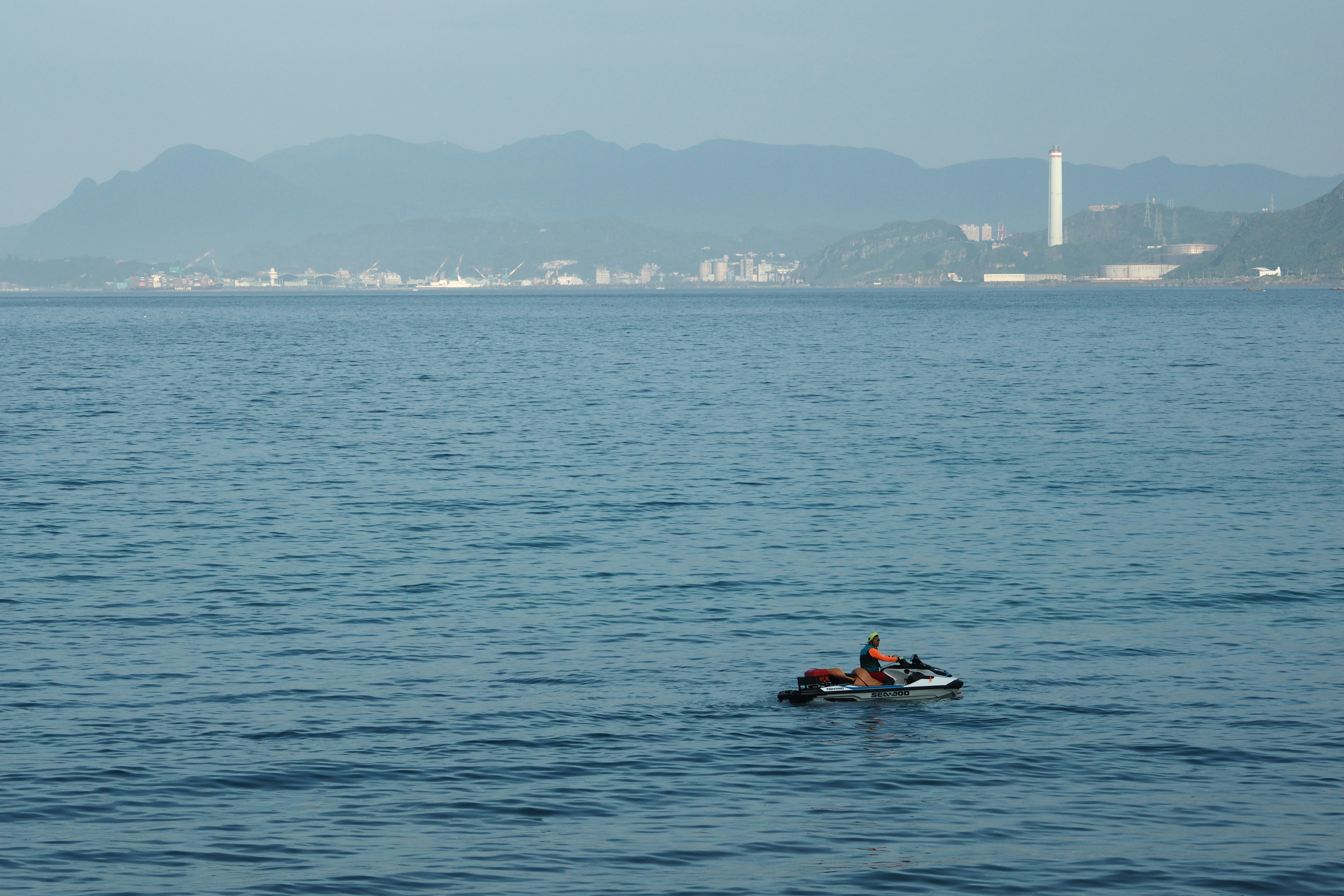 Jet Ski Silhouette on Open Water Beneath Distant Reflections