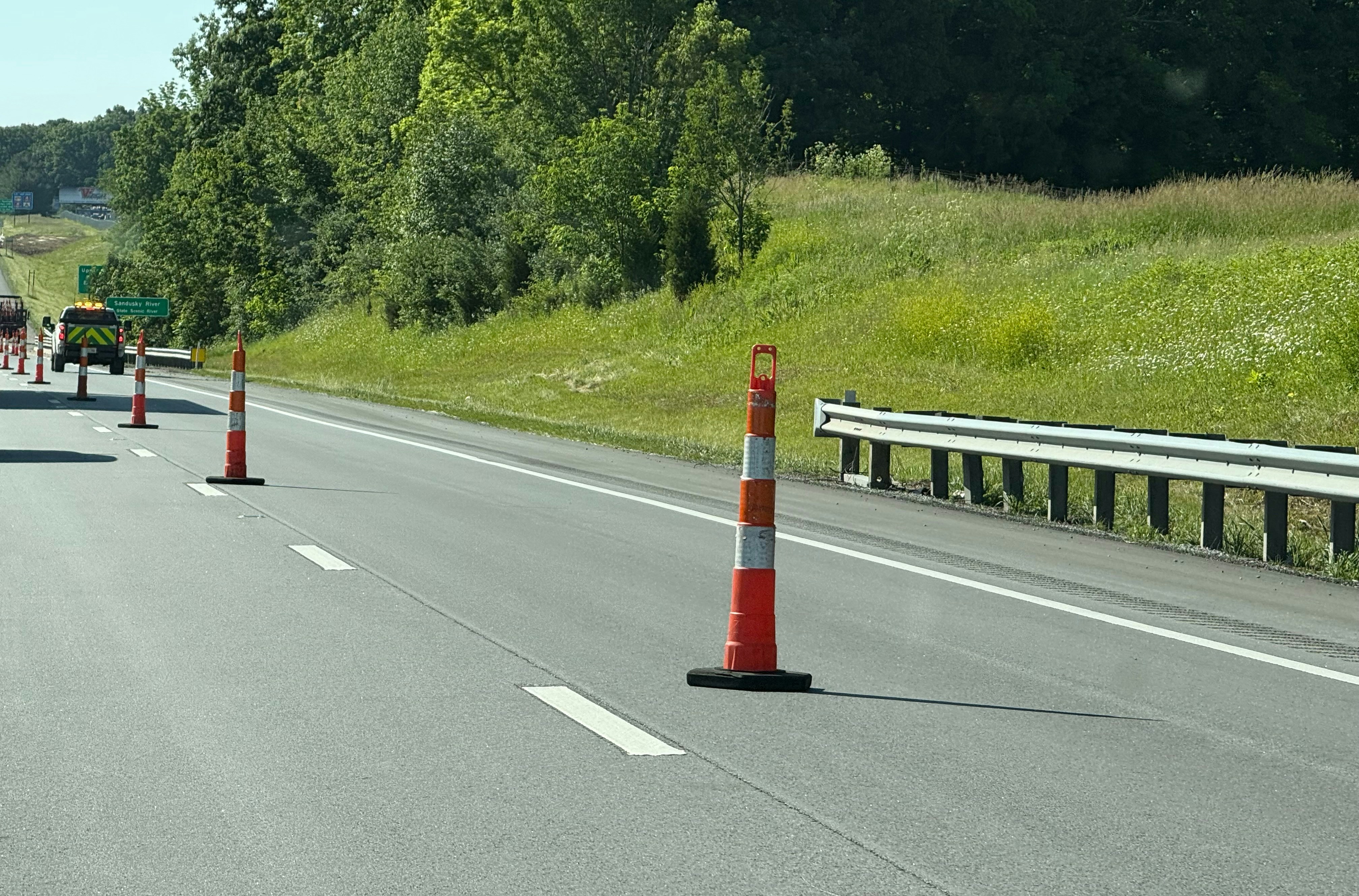 Orange highway construction cones on the road
