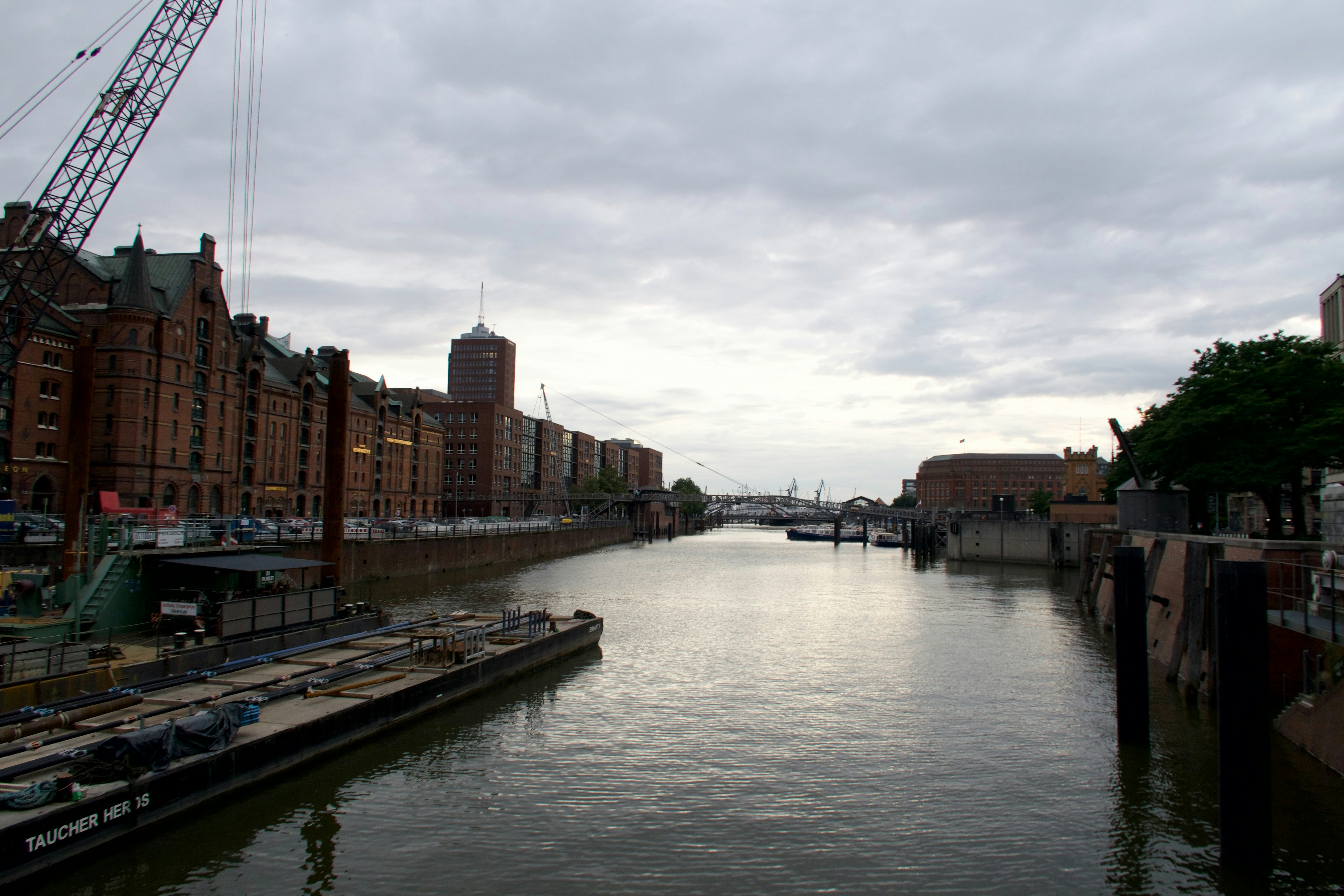 Harbor Framing: Distant Bridge Over Quiet Canal