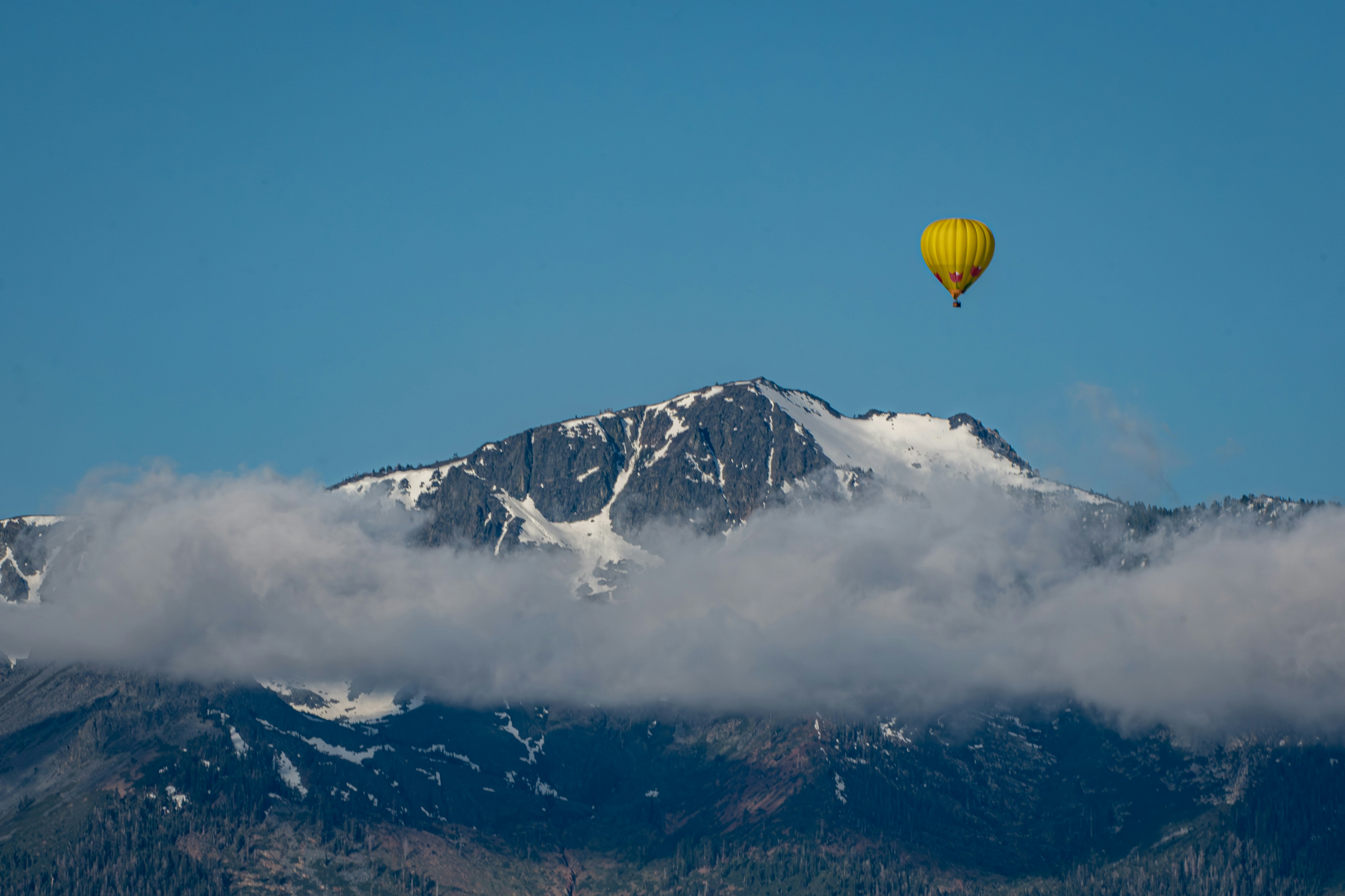 Yellow Balloon Above Snow-capped Ridge