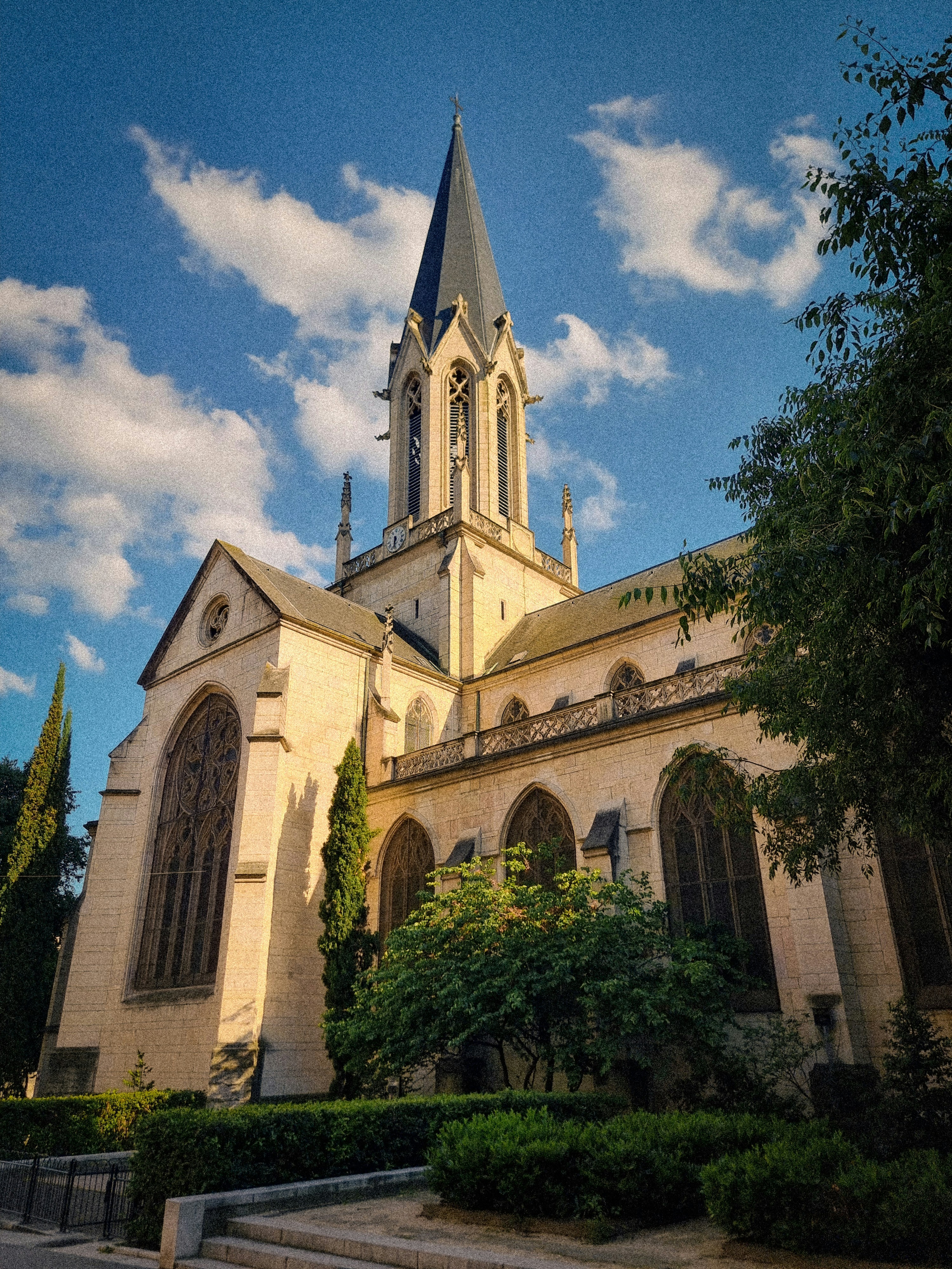 Sunlit Gothic Spire Rising Over a Quiet Campus Church