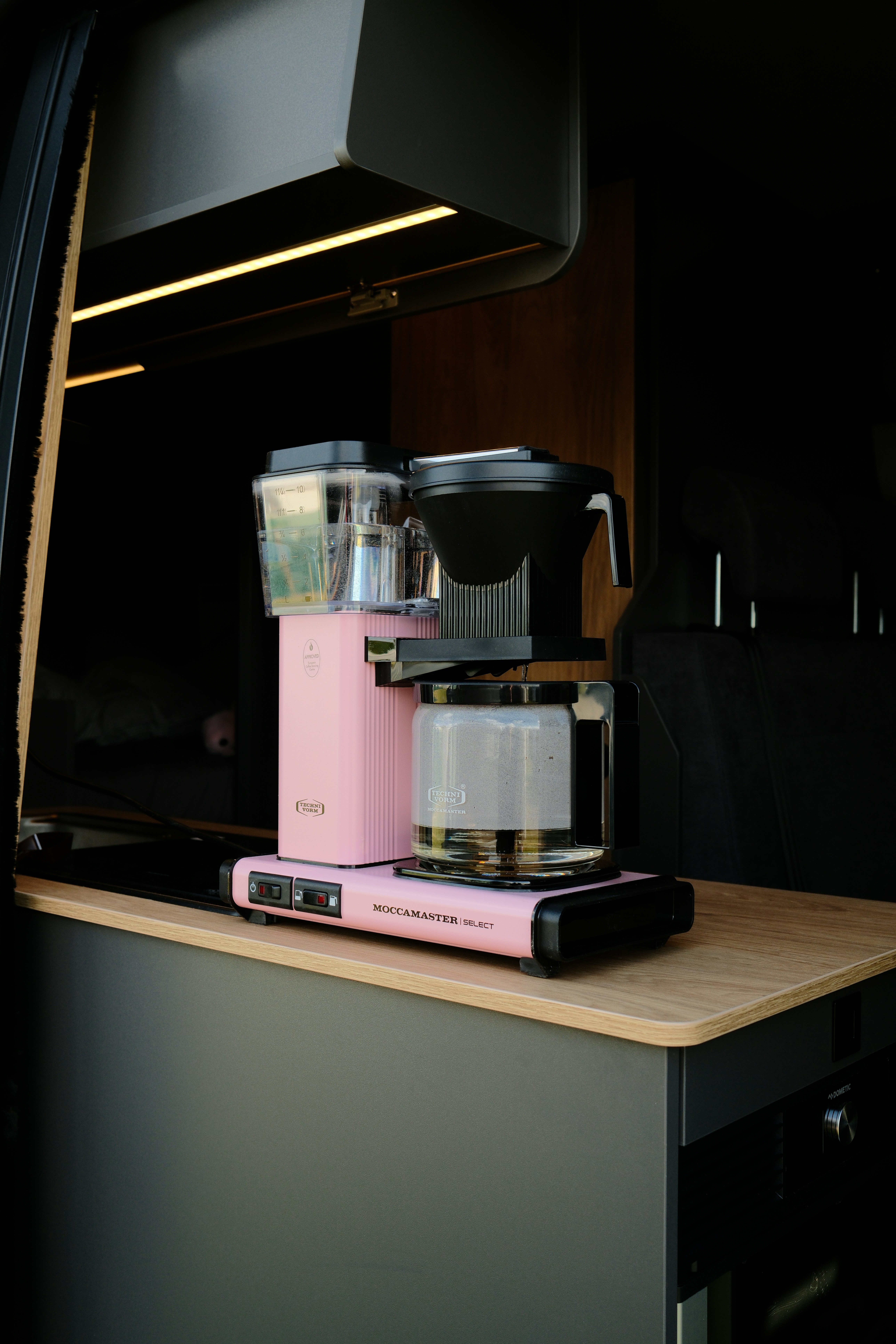Pastel Espresso: A Pink Coffee Station Nestled on a Wood Counter