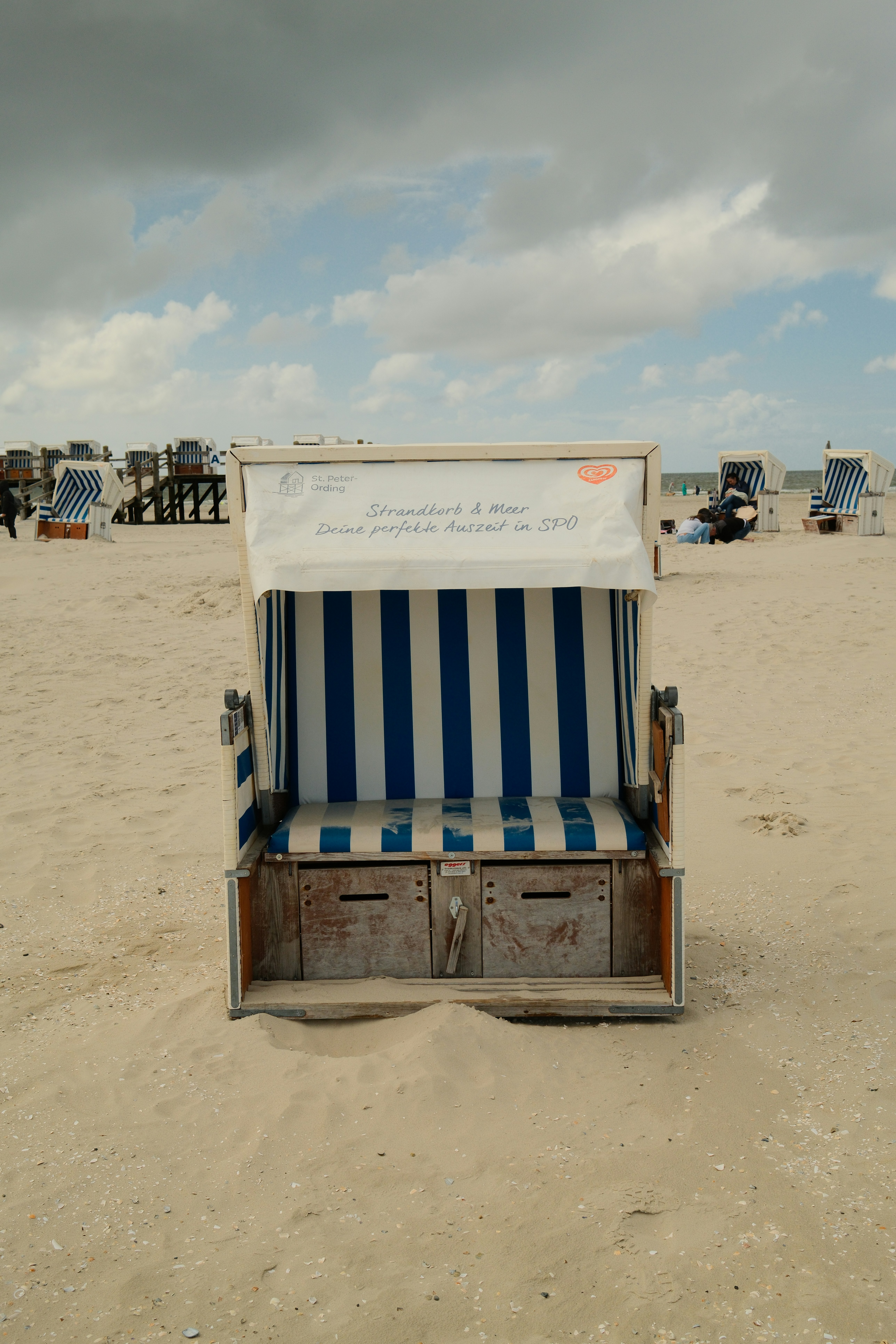 Striped Beach Chair Center Stage on a Quiet Seaside Afternoon
