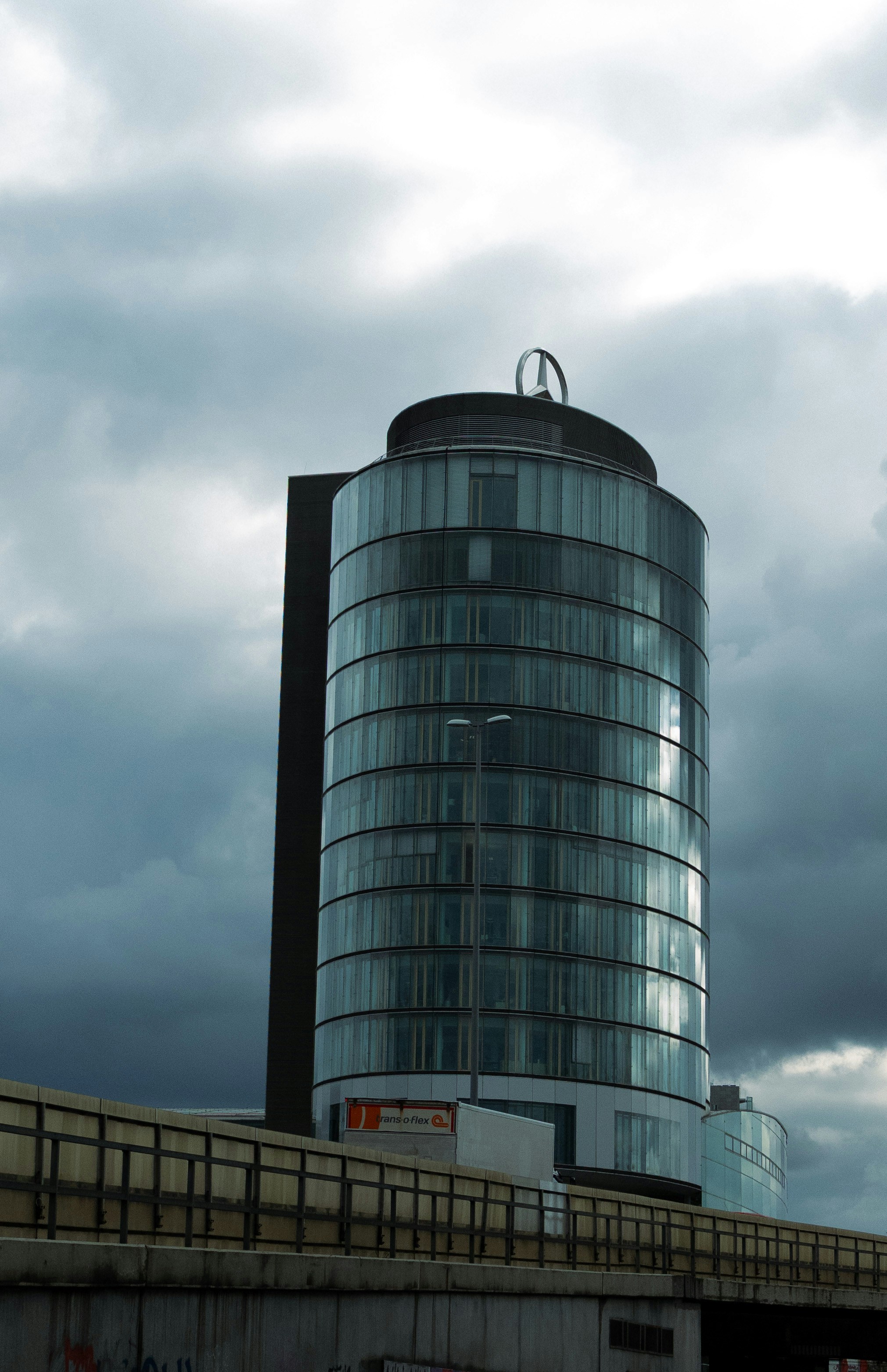 Torus-topped tower slicing through storm-lit sky