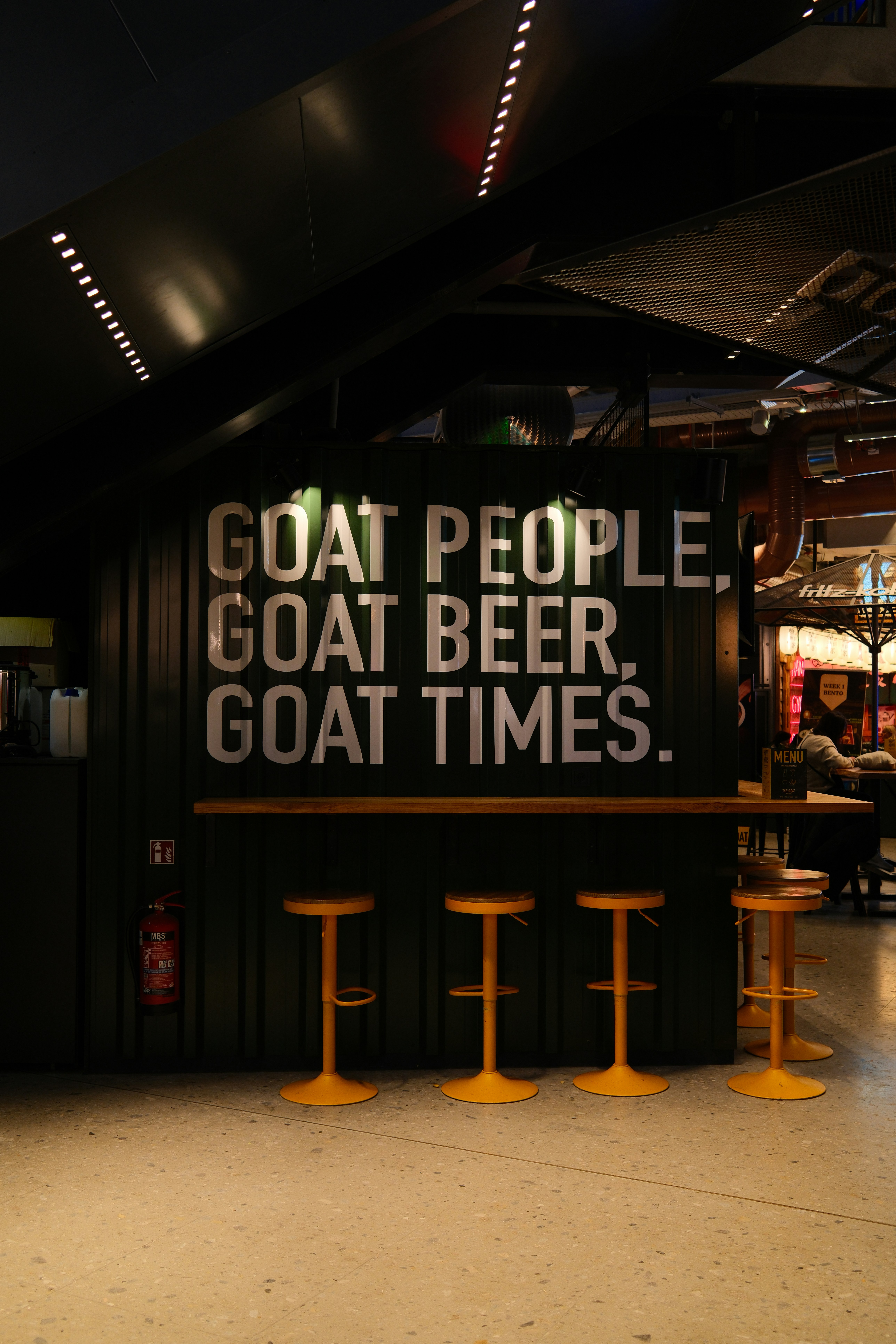 Goat Bridge: A Neon Bar Scene at Dusk