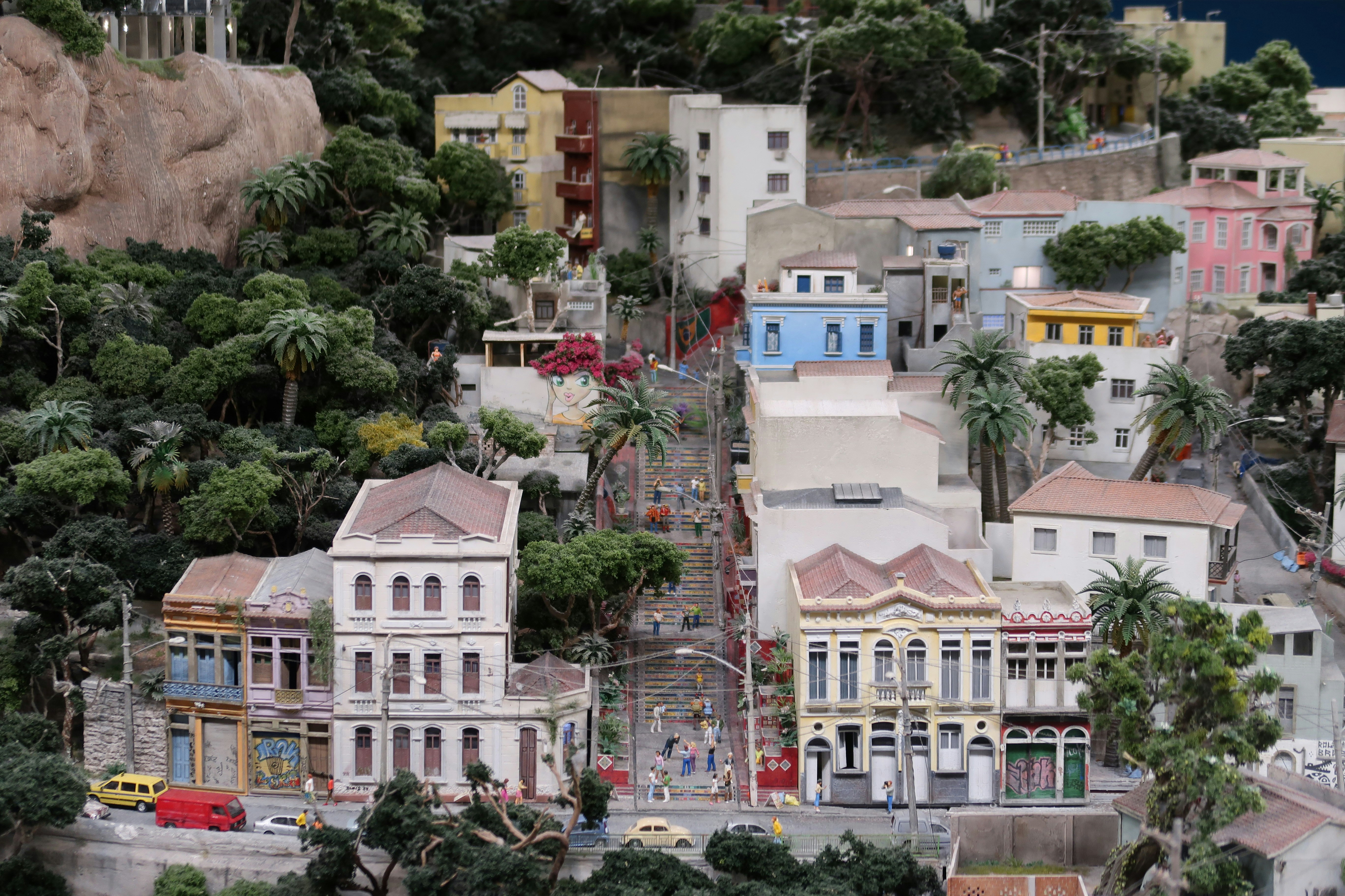 Colorful hillside block of a miniature town tucked into a tropical landscape