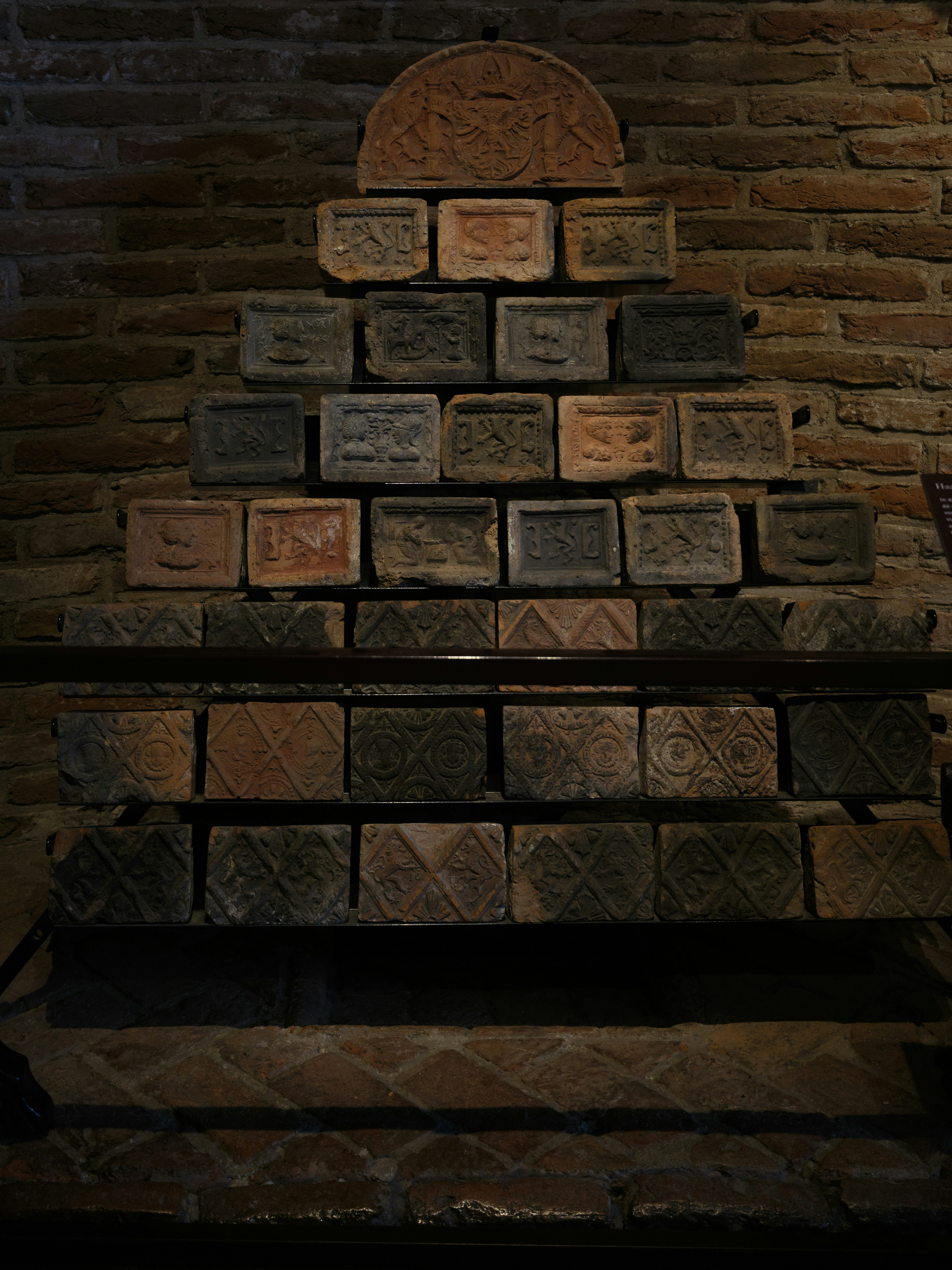 Stonework Hieroglyphs: A Pyramid of Bricked Reliefs in Dim Light