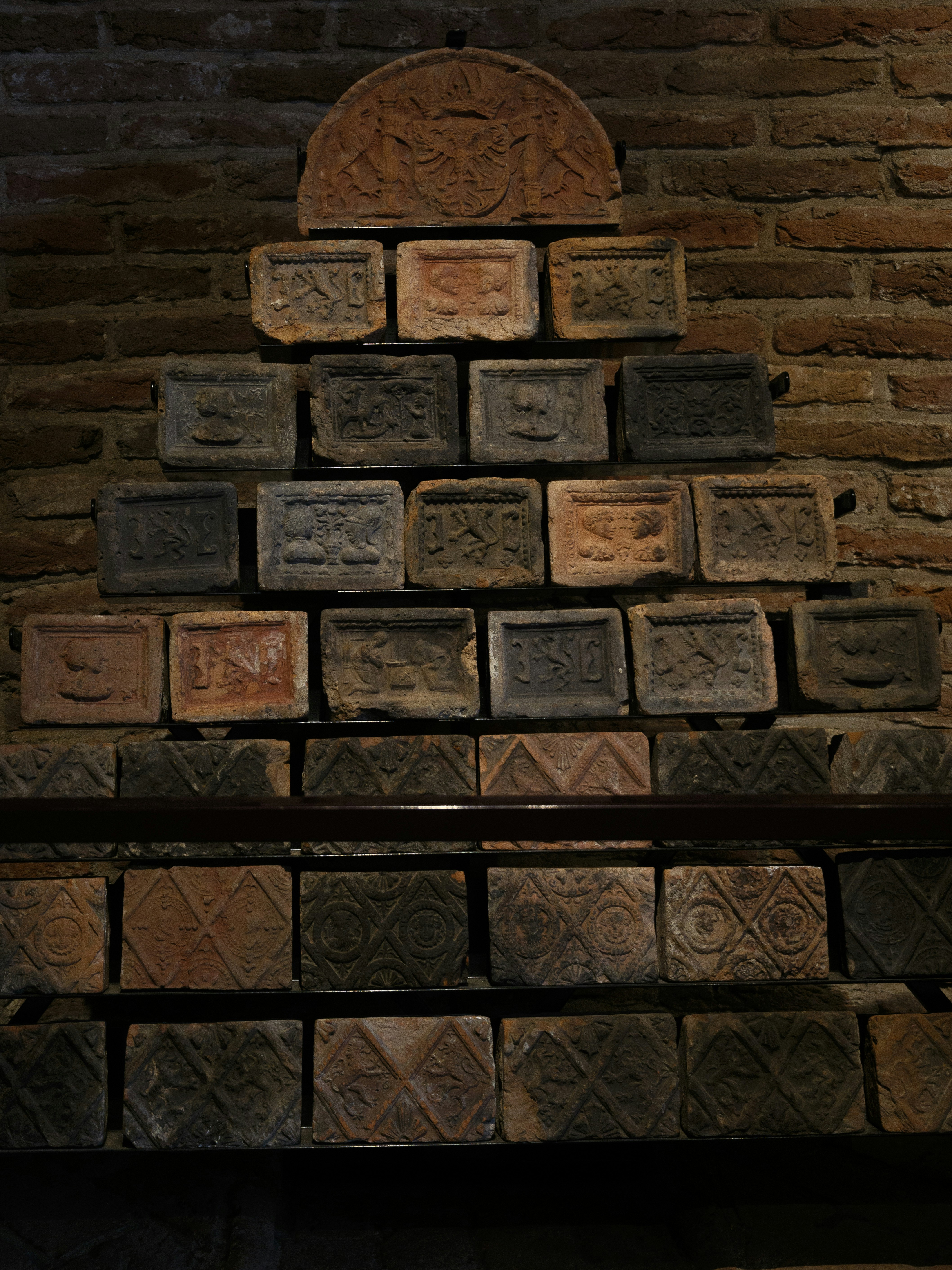 Stacked Bricks of Time: A Dimly Lit Display of Carved Clay