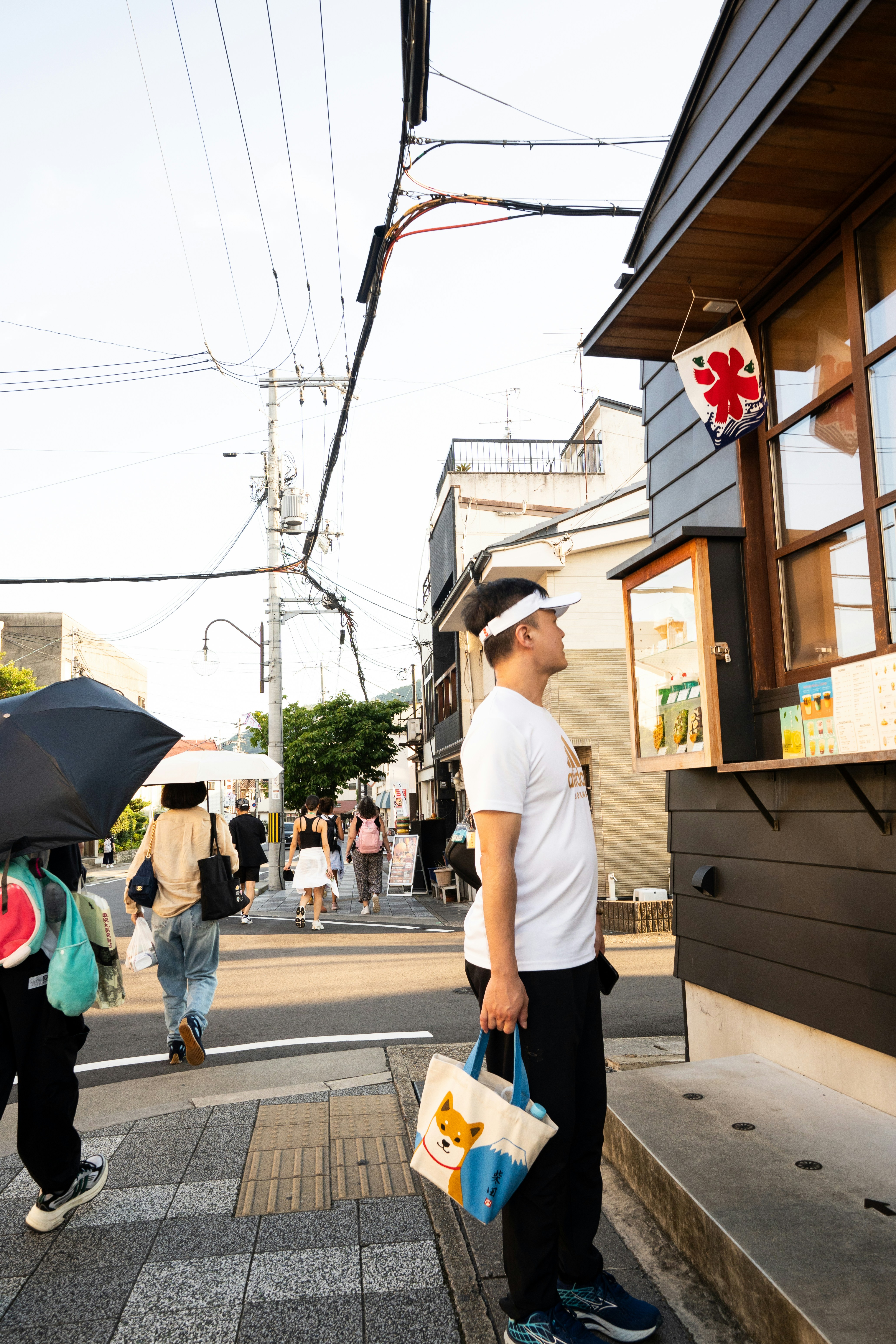 Street Vendor Window Focus: Lapel Banner and Energetic Pedestrian Scene