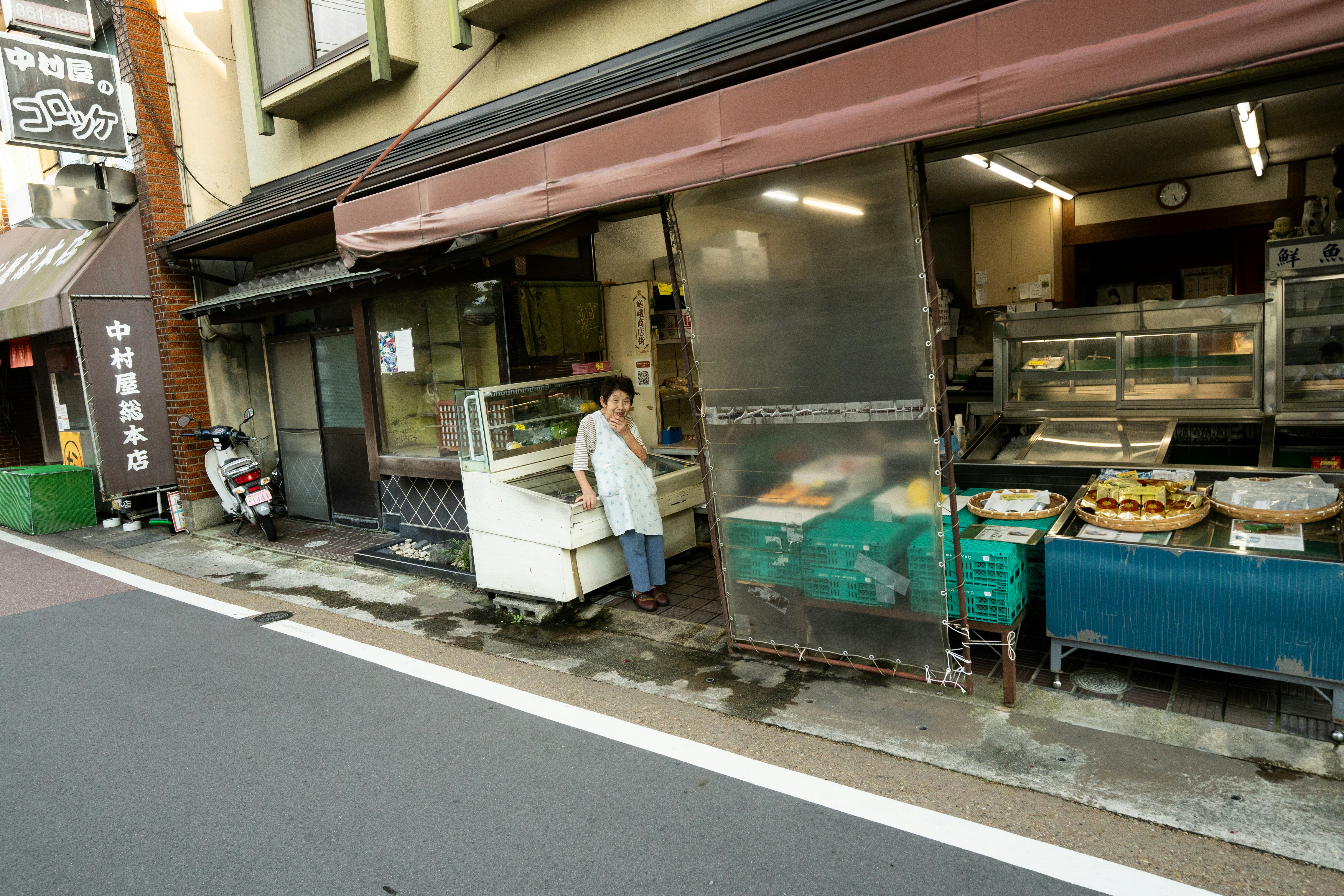 Street-side Market Quietly Open: A Worker by a Food Stall