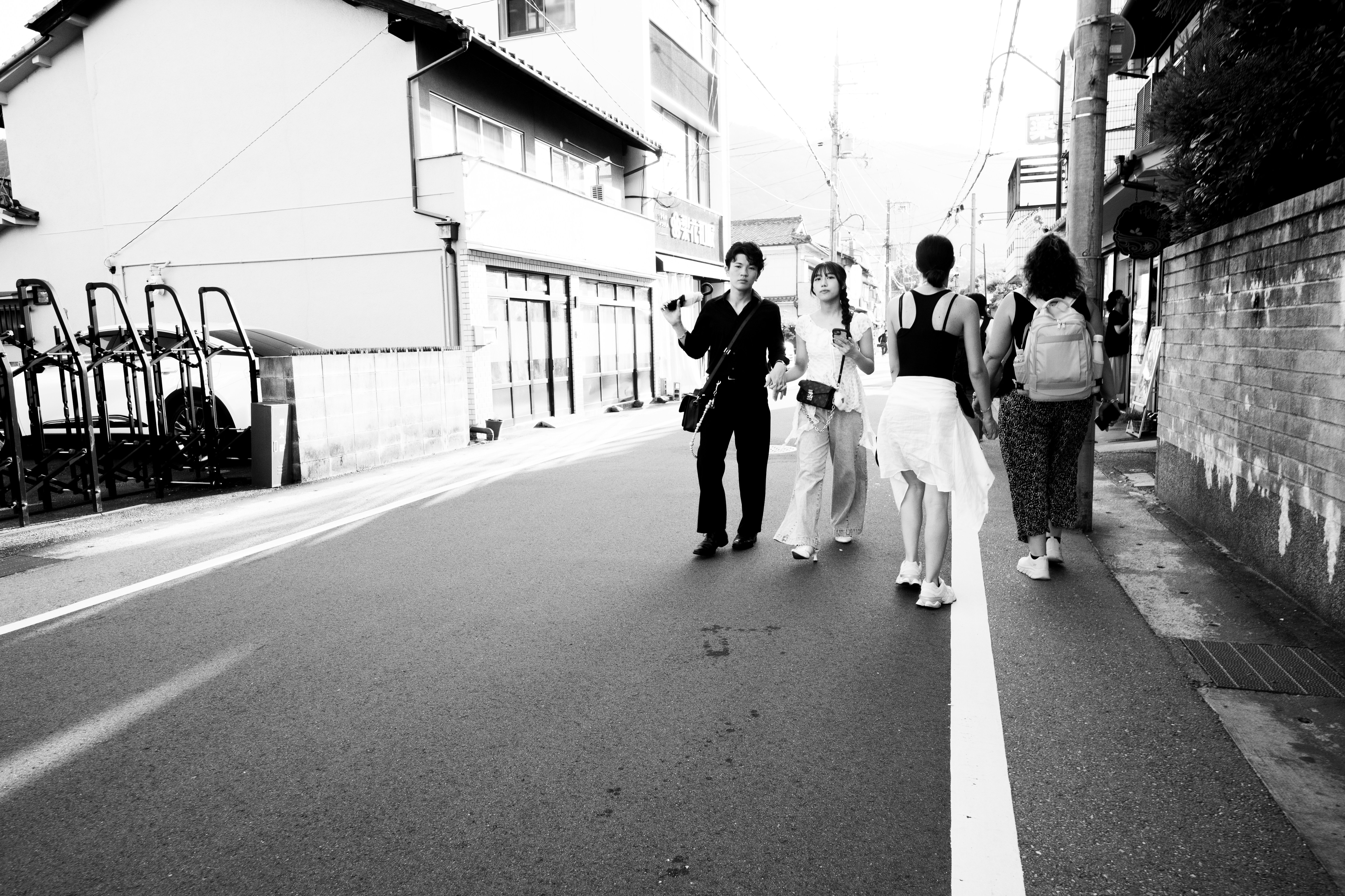 Group of Friends Pause Mid-Street as Their Photographer Captures the Moment
