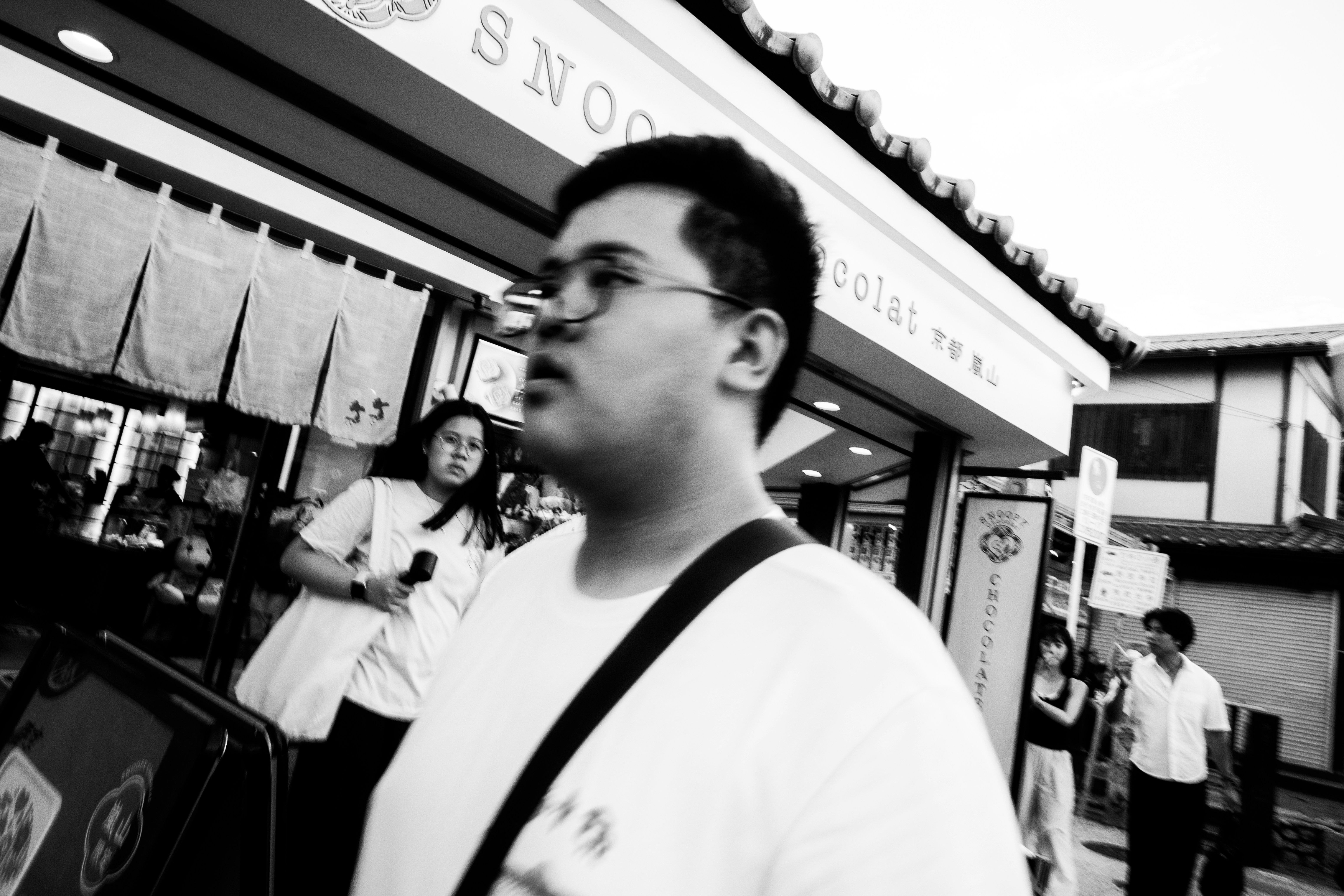 Blurred Street Portrait: A Quiet Moment in a Busy Corridor