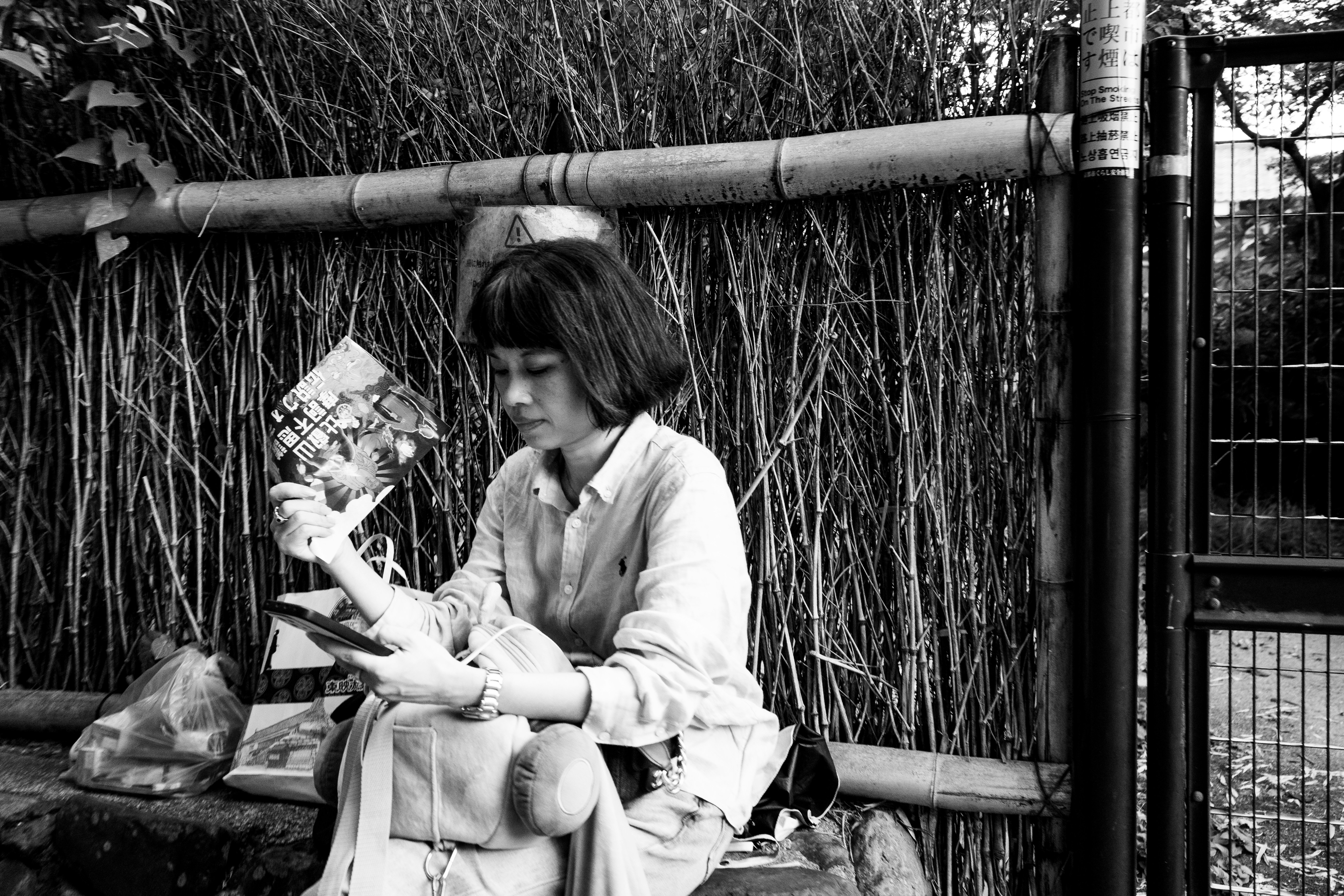 Silent Reading on a Street Bench