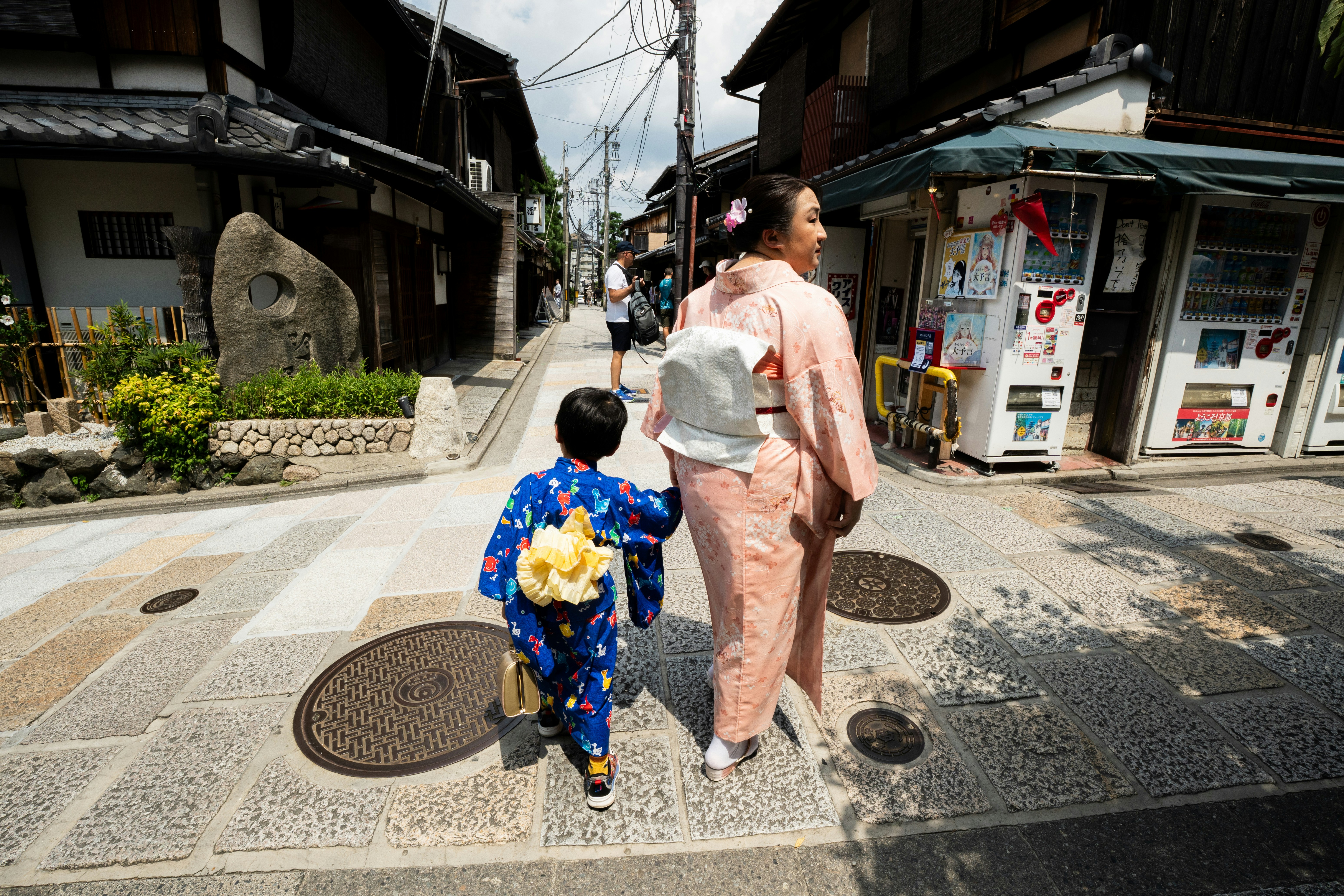 Cross-Cultural stroll: Kimono and Kimono-Blue on a Quiet Japanese Street