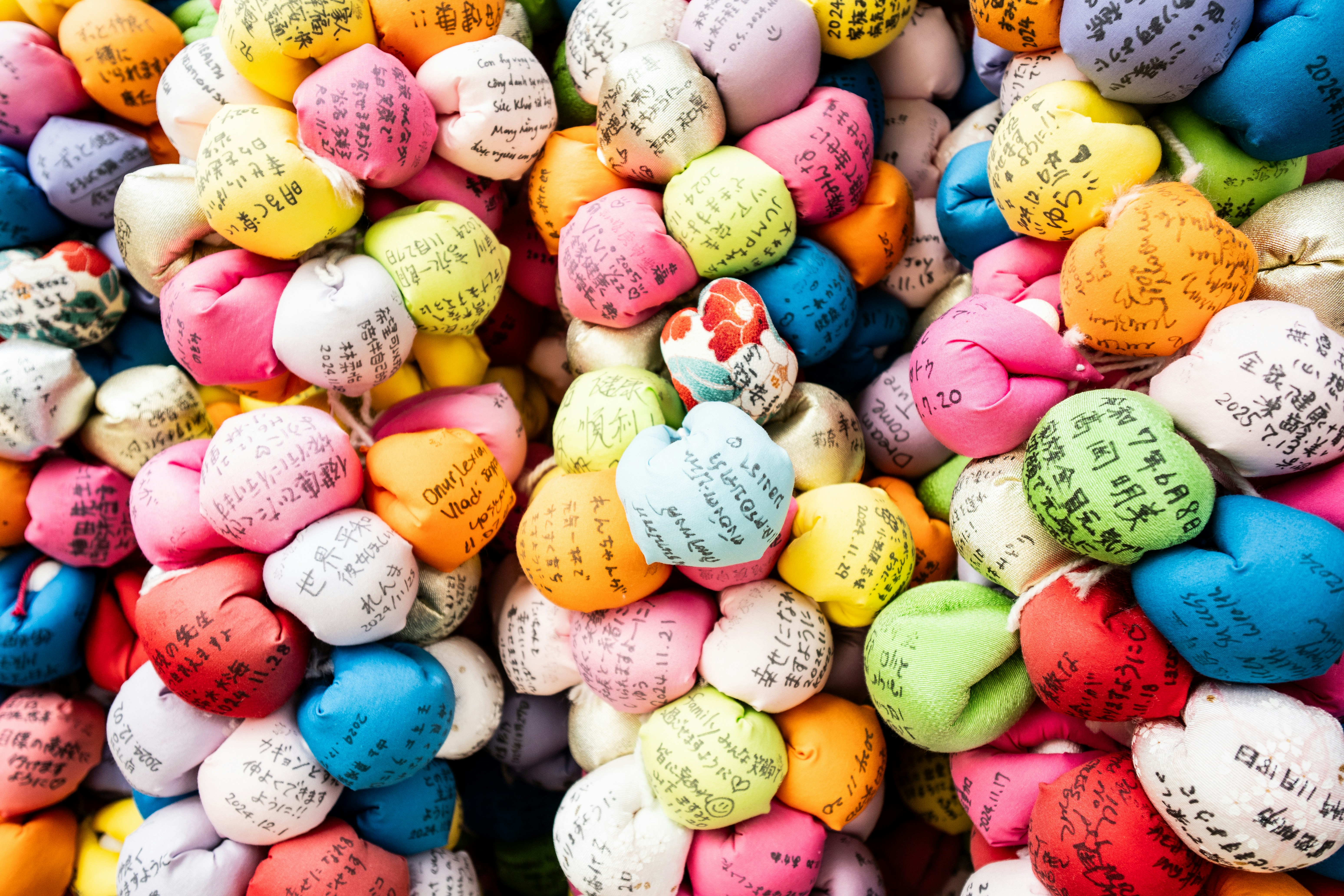 Many colorful, round paper objects with writing.