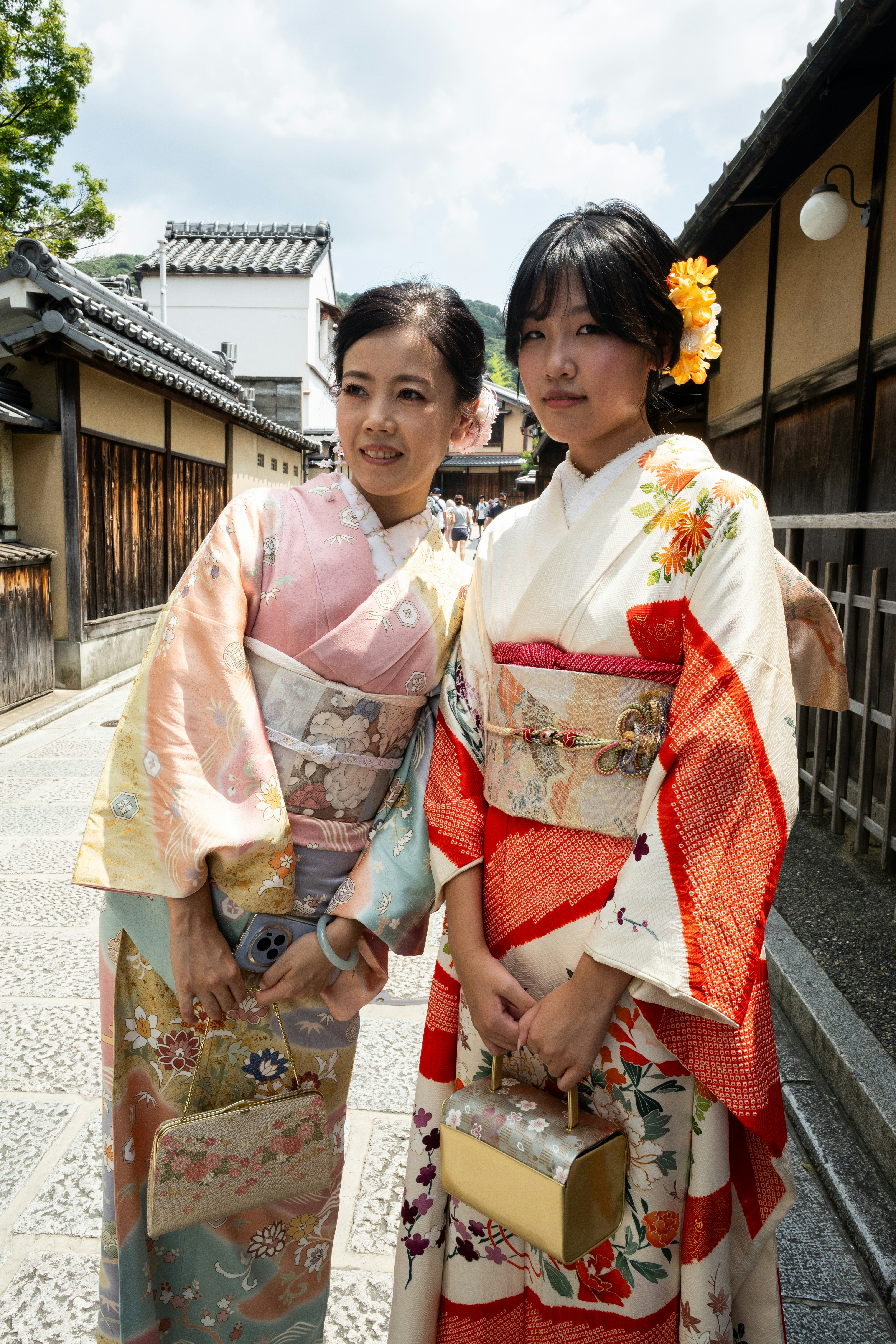 Two young women in colorful kimonos on a traditional street.