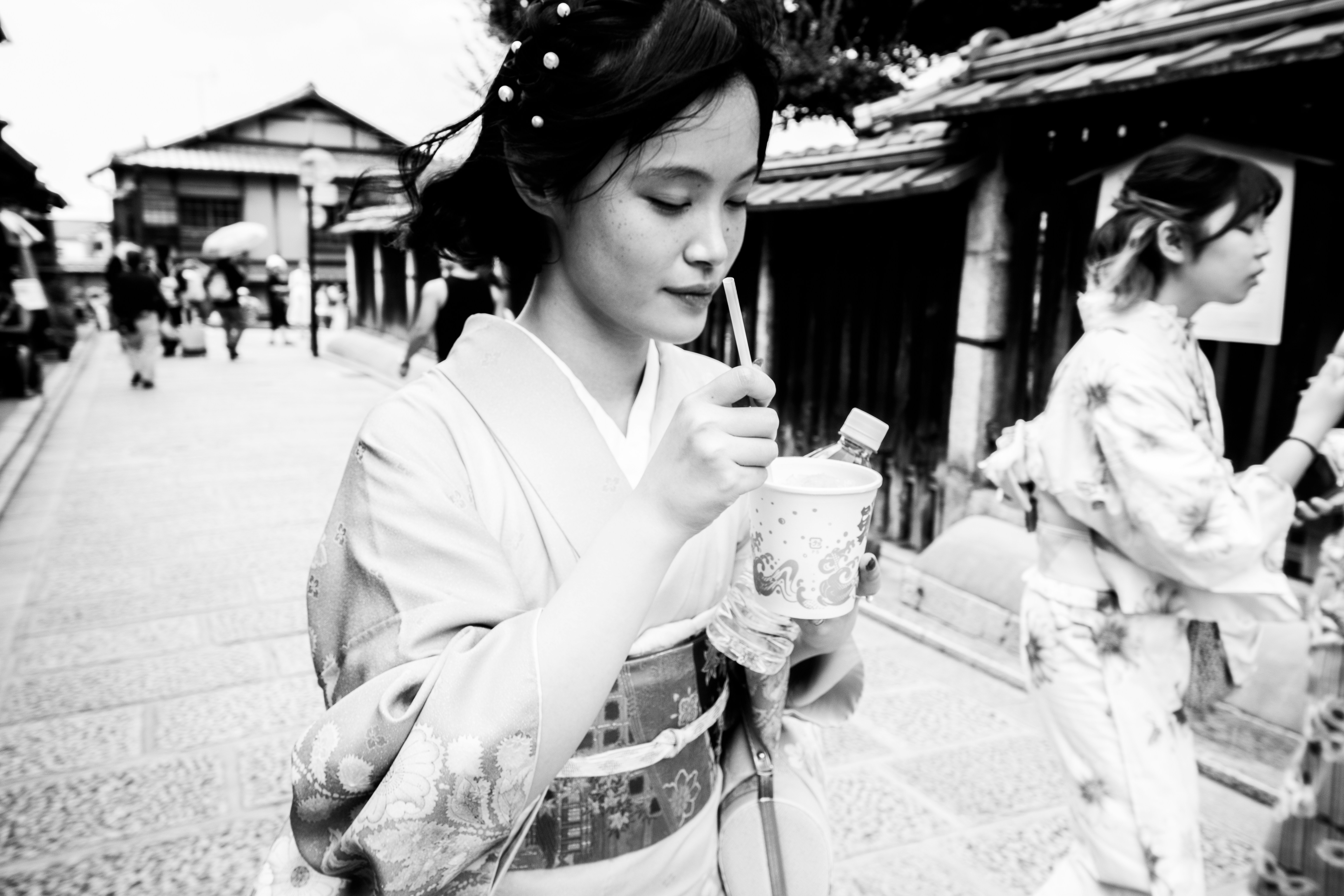 Gentle Moment: A Kimono-clad Tea Ceremony in a Quiet Street