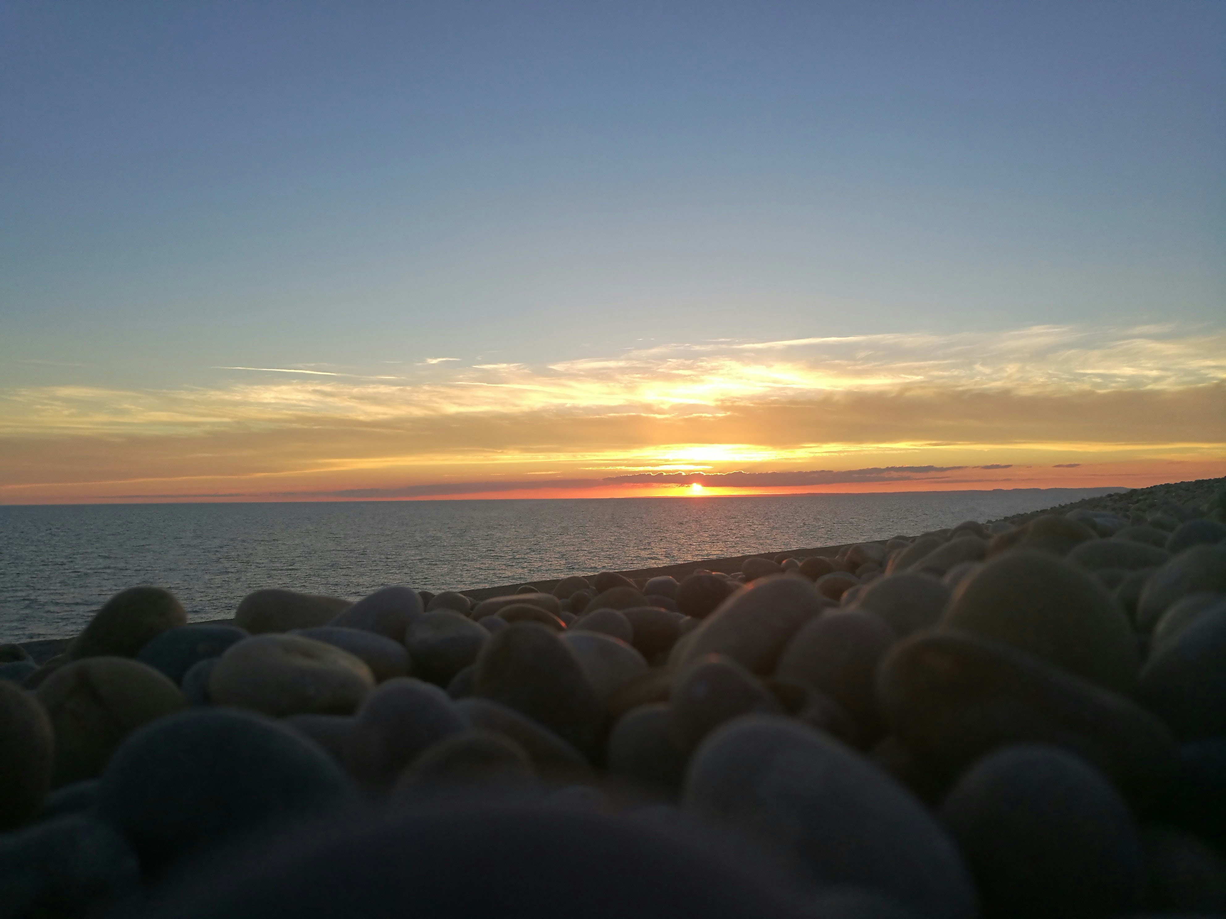 Sunset Over Pebble Beach: Horizon Gold