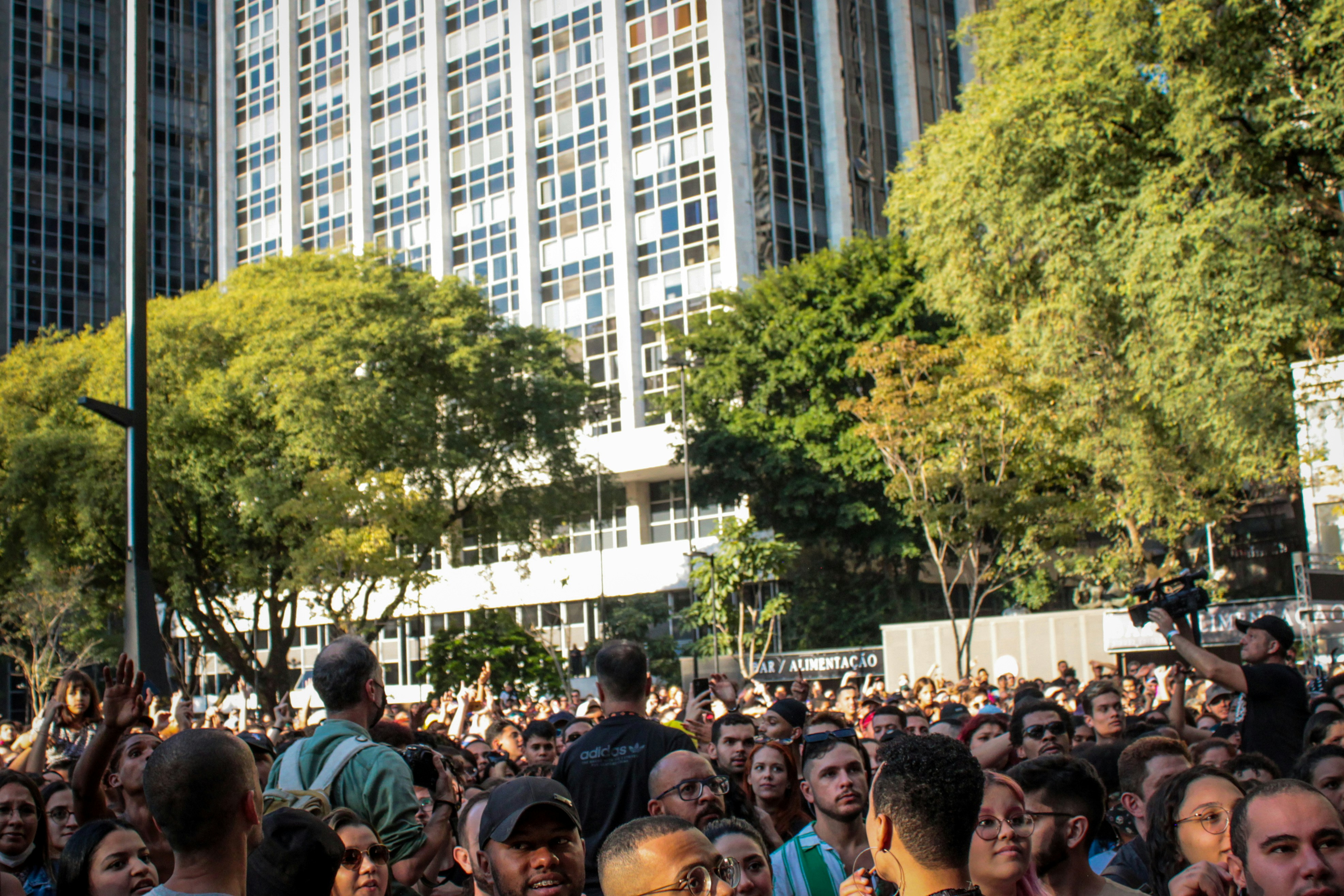 Crowd at the Urban Canyon: Faces Beneath Glass and Sky