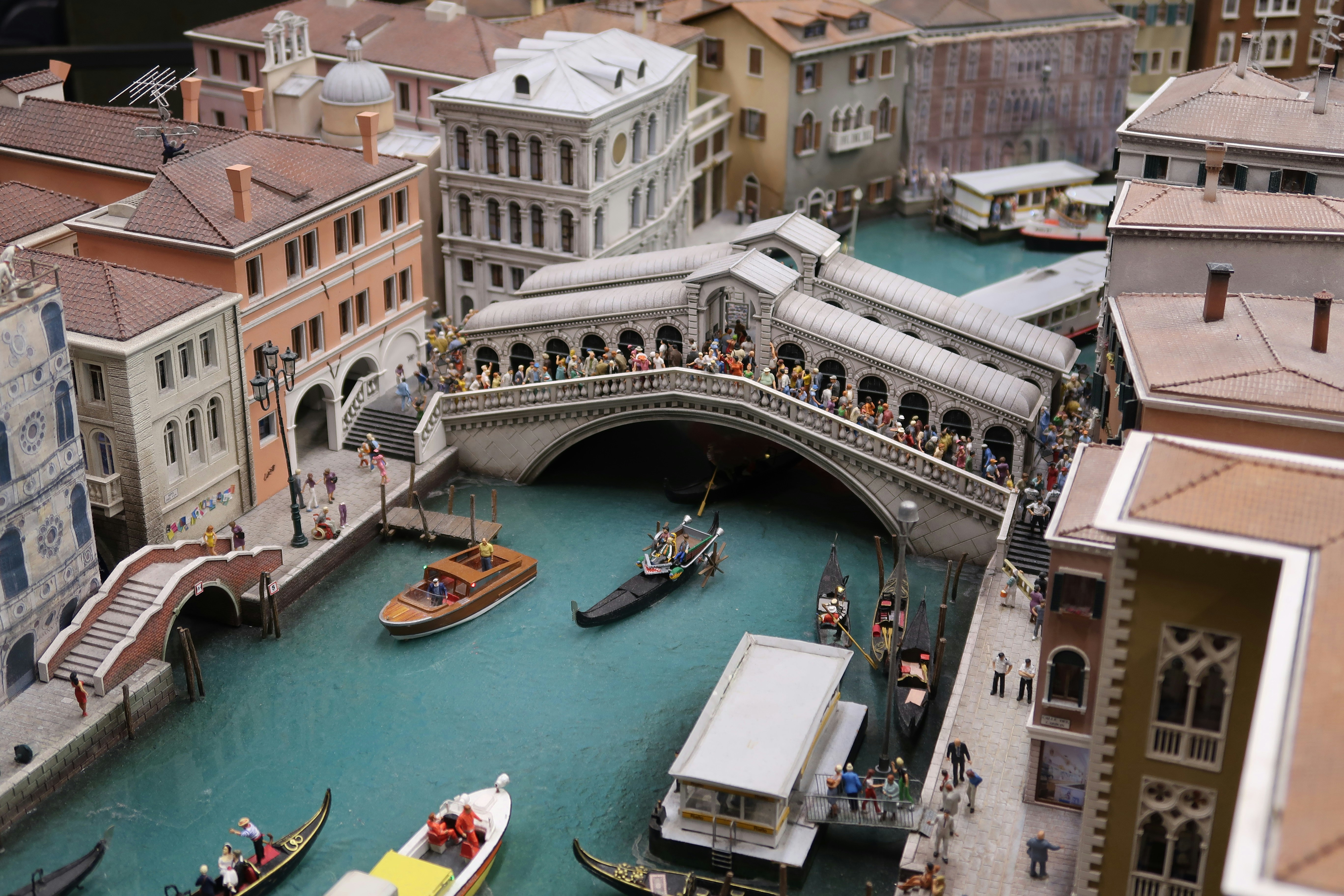 Canal Crossing: A Stone-Arch Bridge Framed by a Parade of Boats