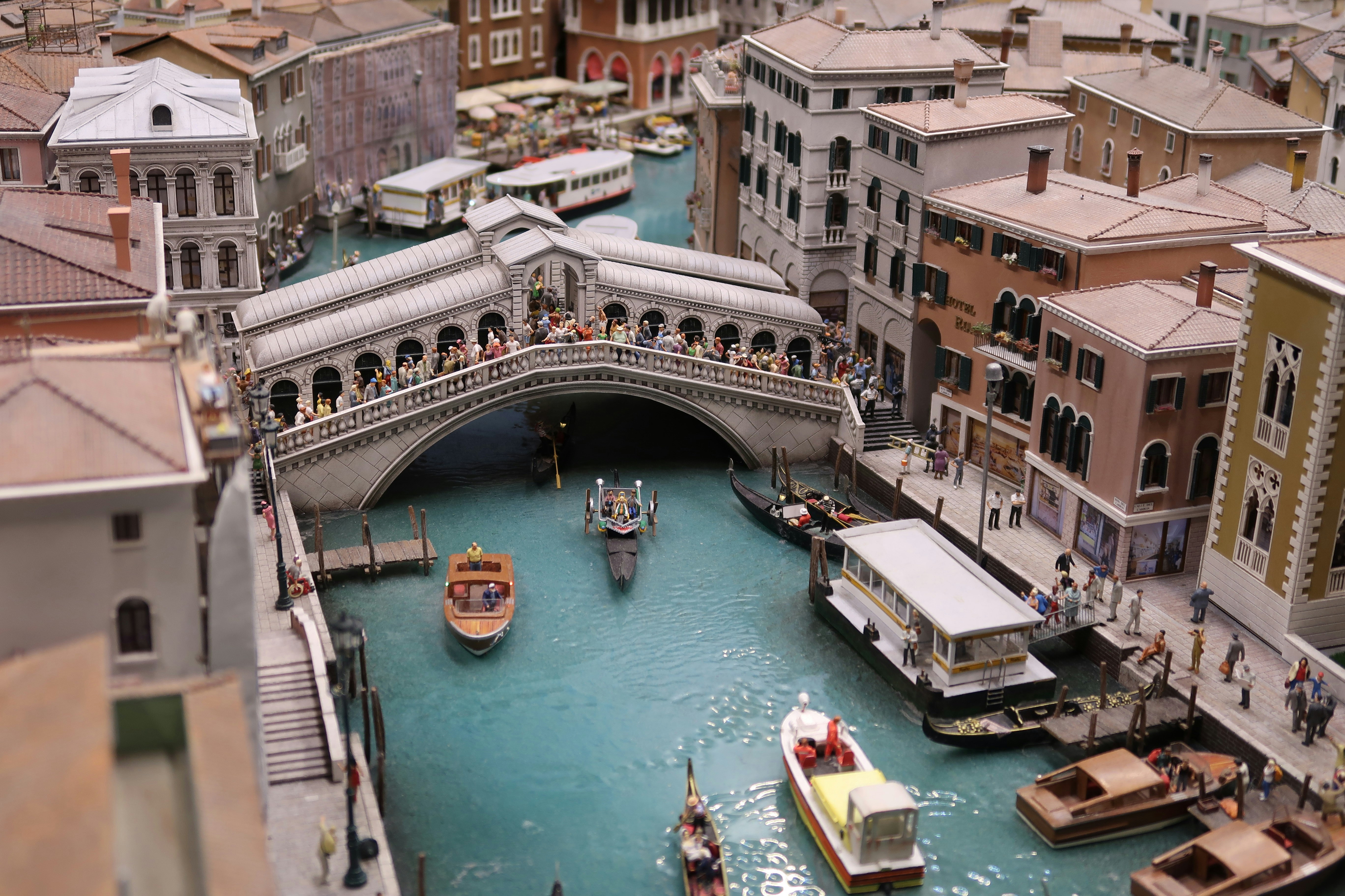 A Canal Crossing: miniature Venice with a Curved Bridge and Boats