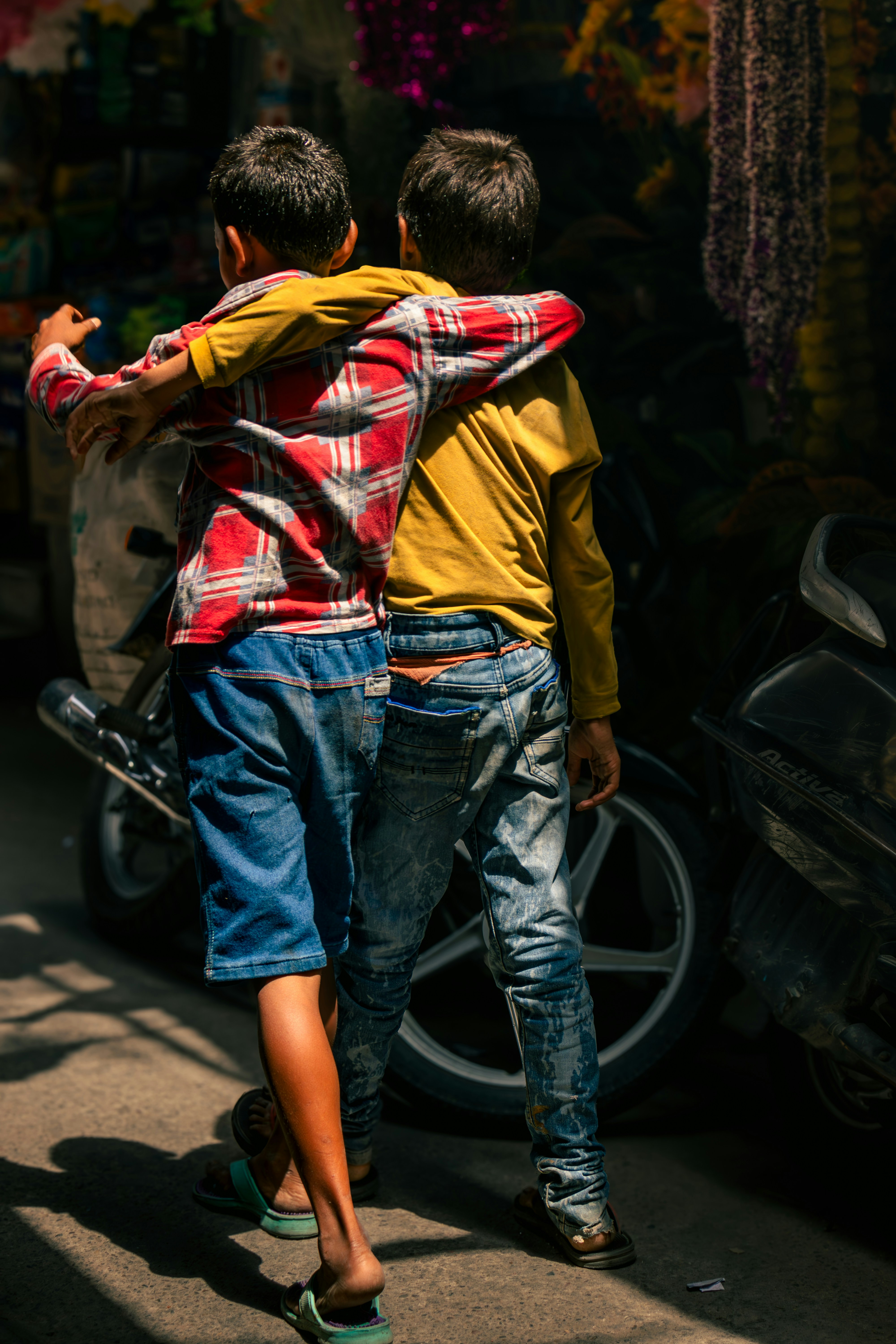 Two Friends in a Sunlit Street Embrace