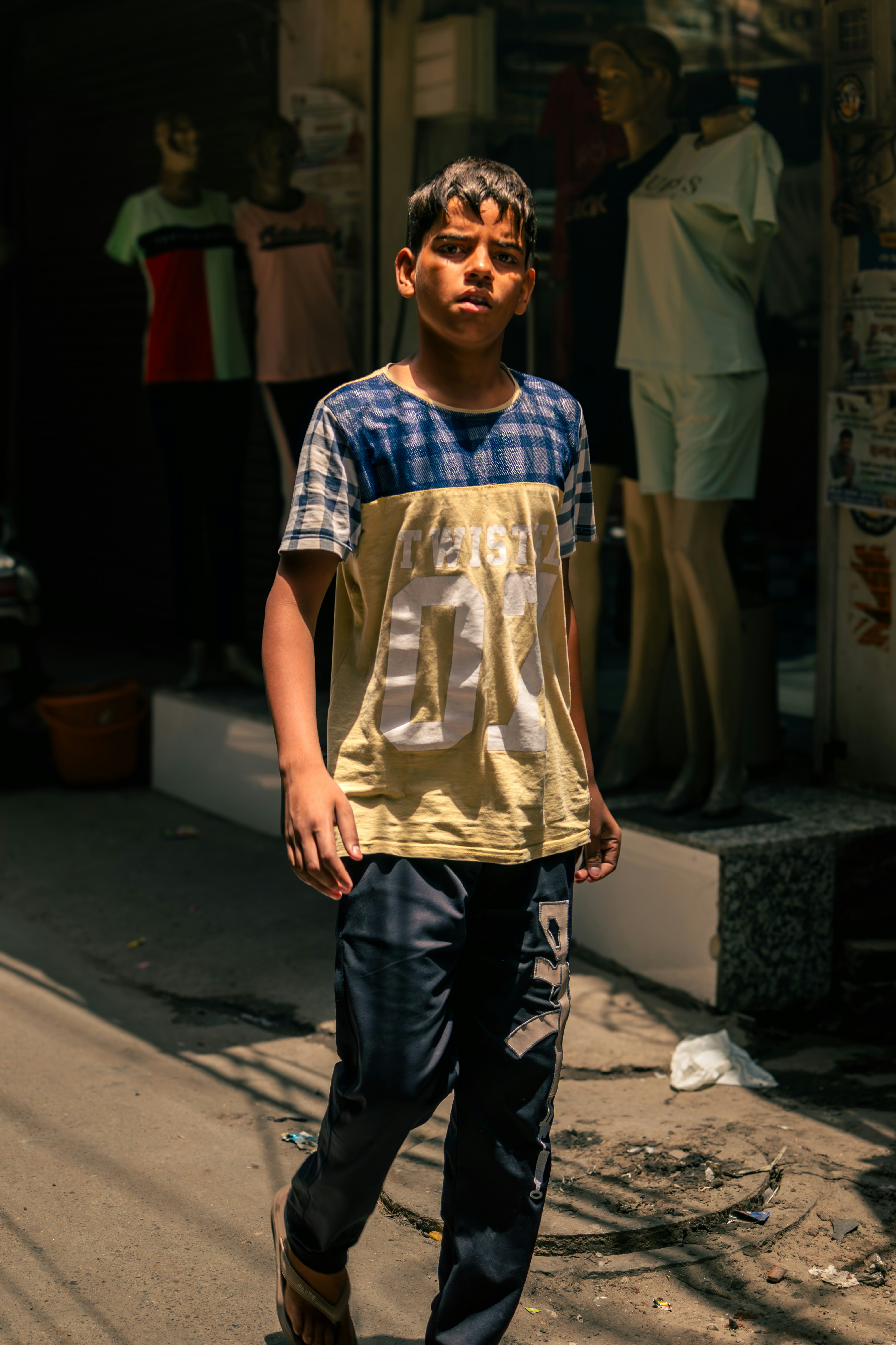 Boy wandering in a street during the extreme Indian summers.
