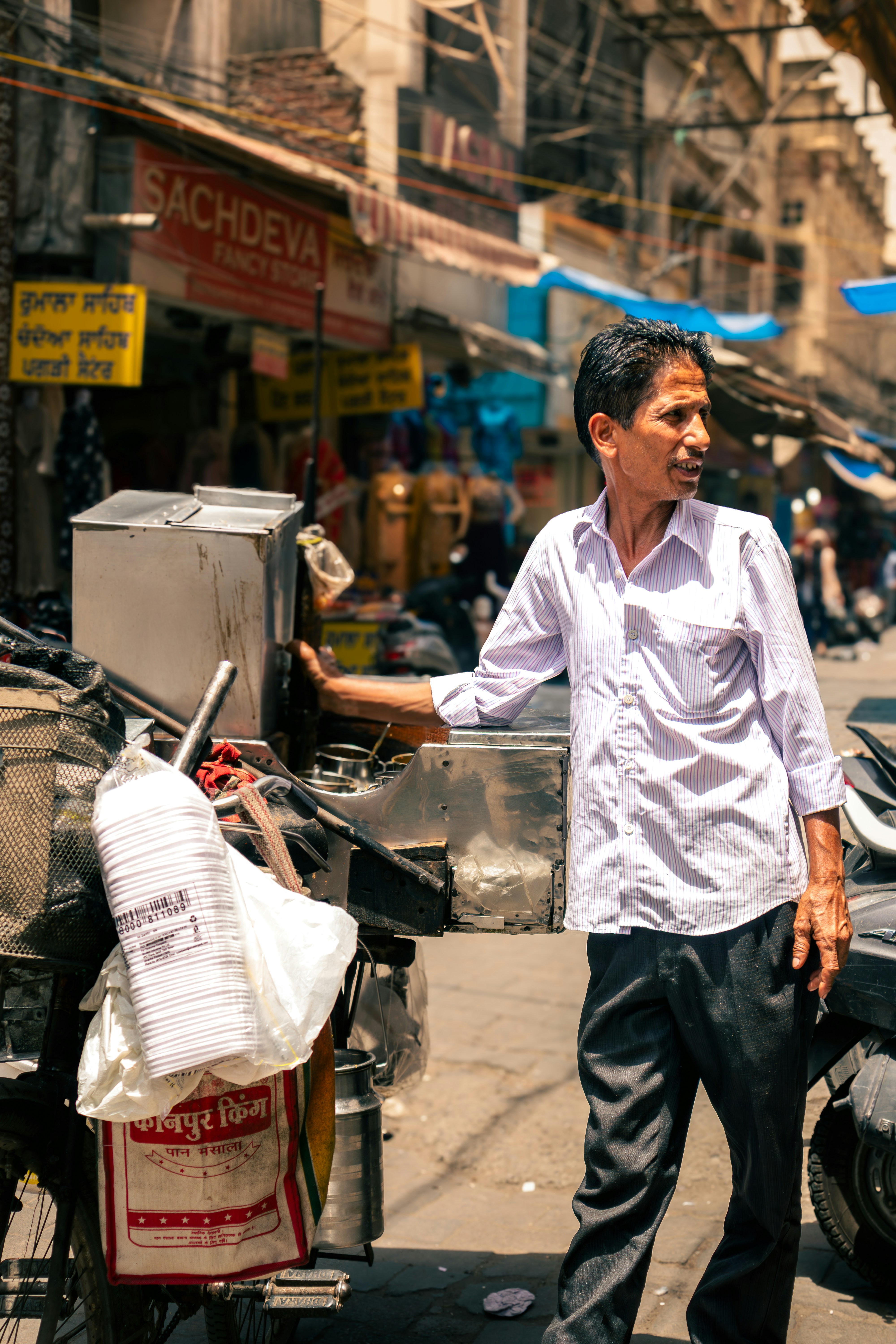 Street Vendor in a Bustling Market: A Portrait of Focus and Motion