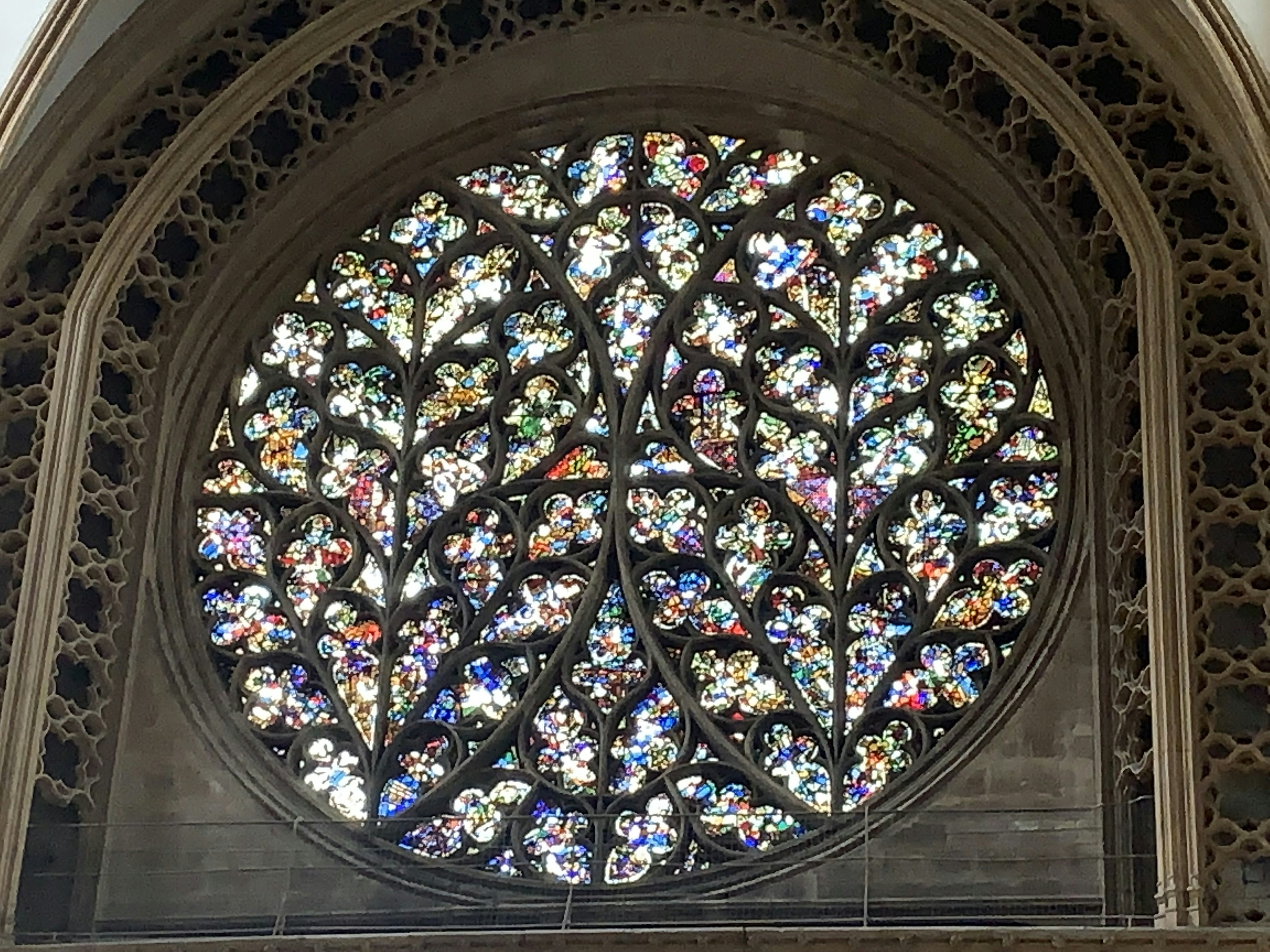 Circular stained-glass rose window: a kaleidoscope of color and light