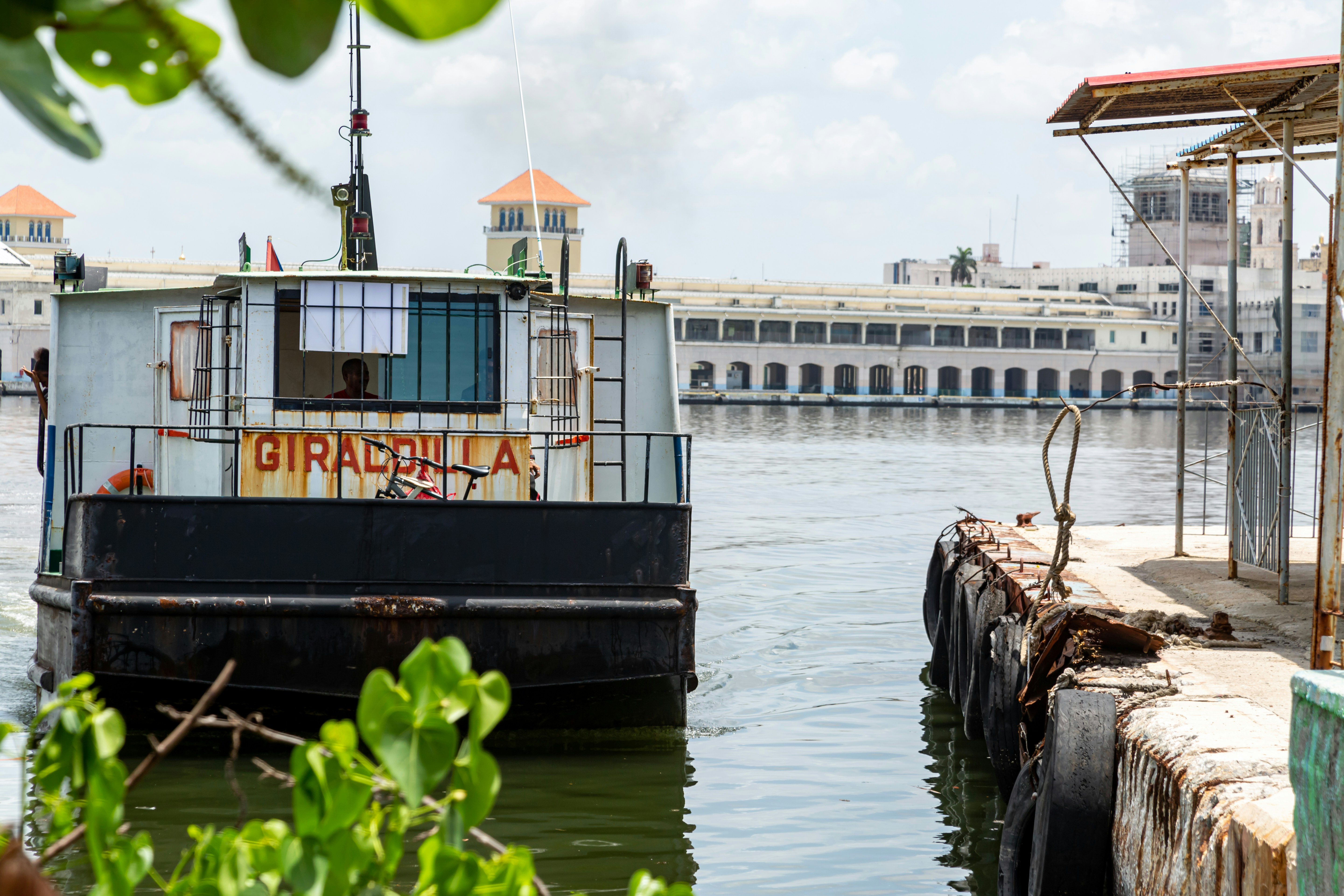 Docked Boat with Industrial Pier under a Bright Sky