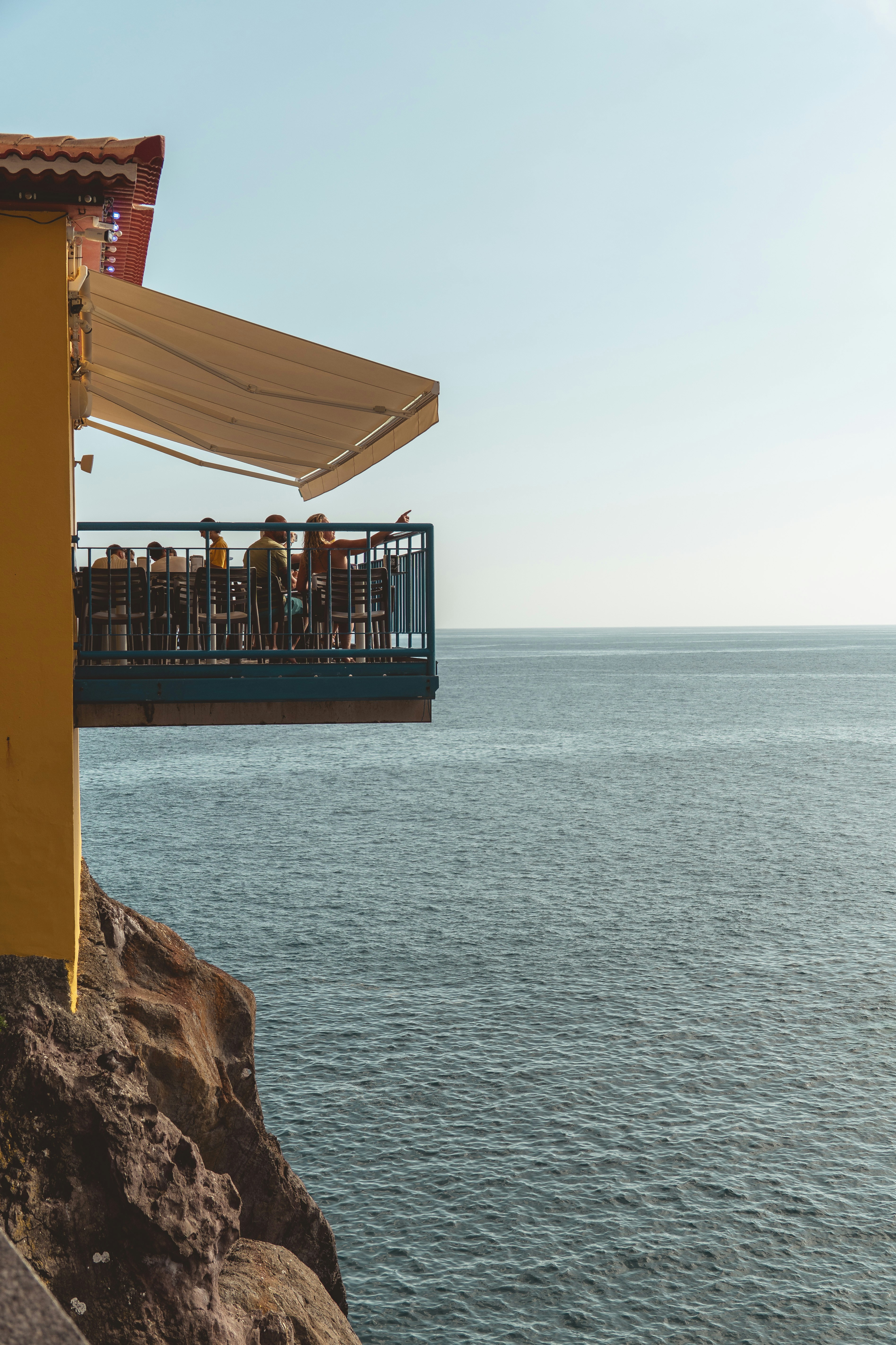 Clifftop Café Portrait: People on the Terrace Overlooking the Sea