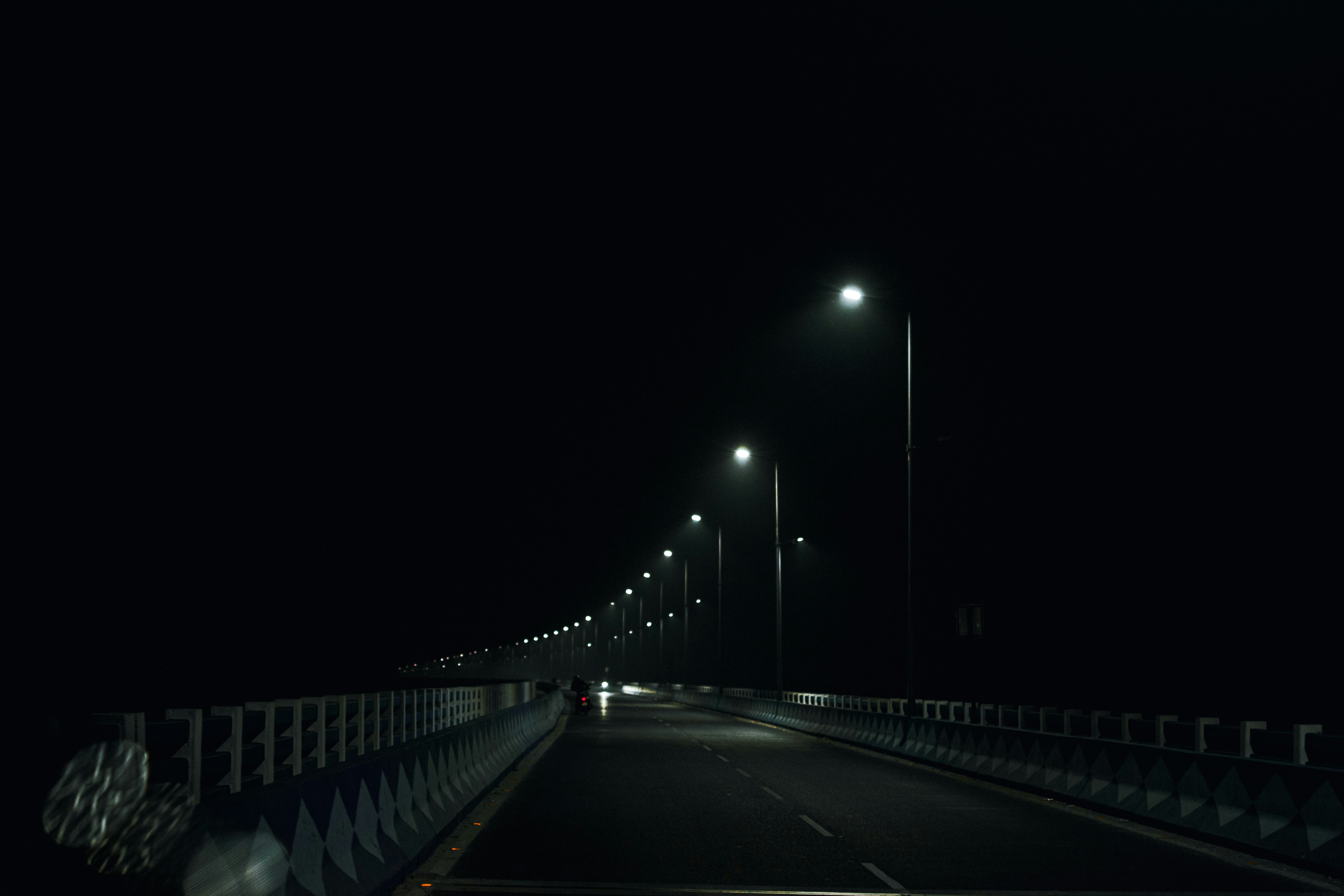 Lone Highway Under a Line of Quiet Streetlights