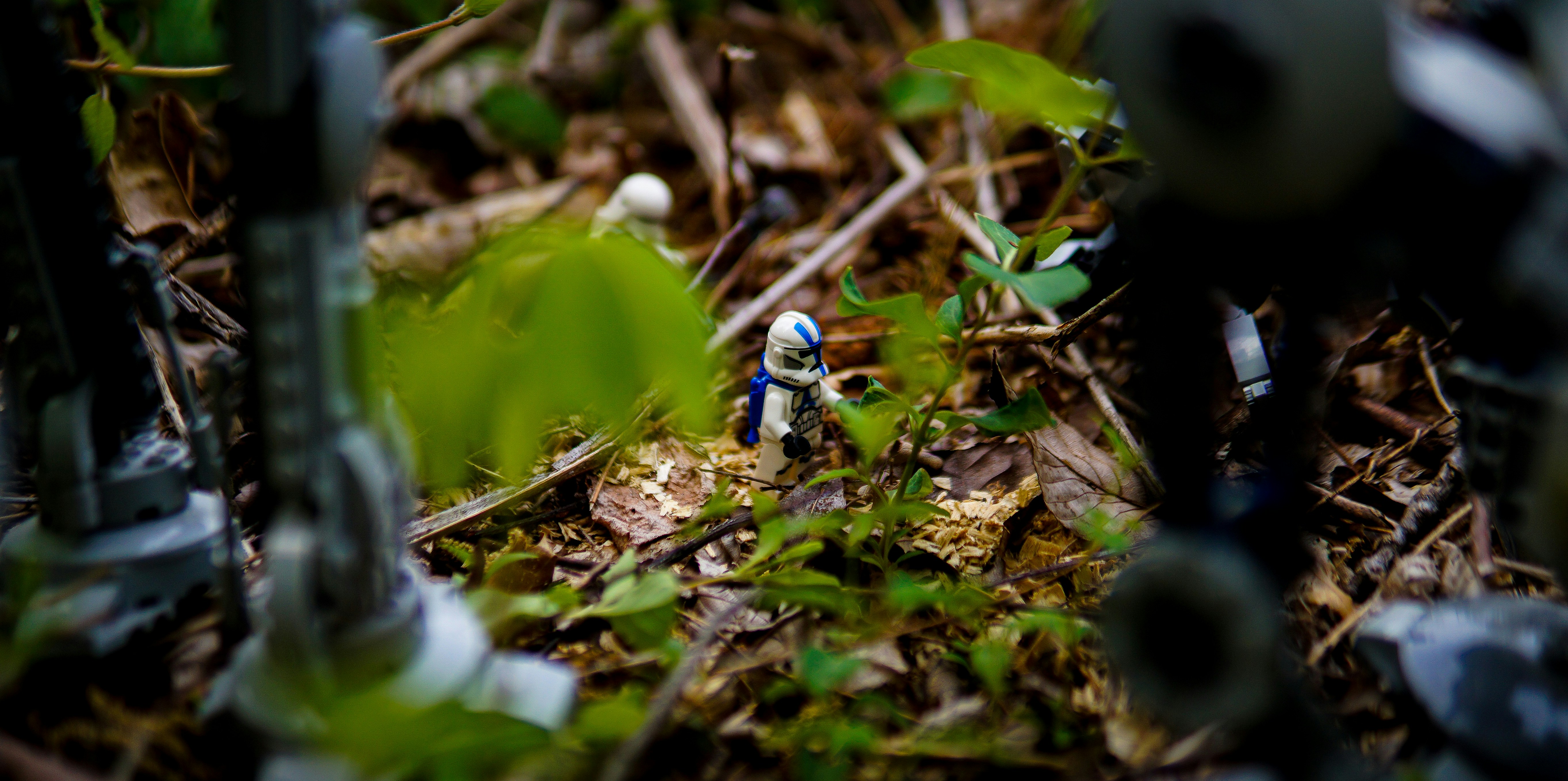 Hidden Micro-Scout: A Tiny Figure Amid Field Gear