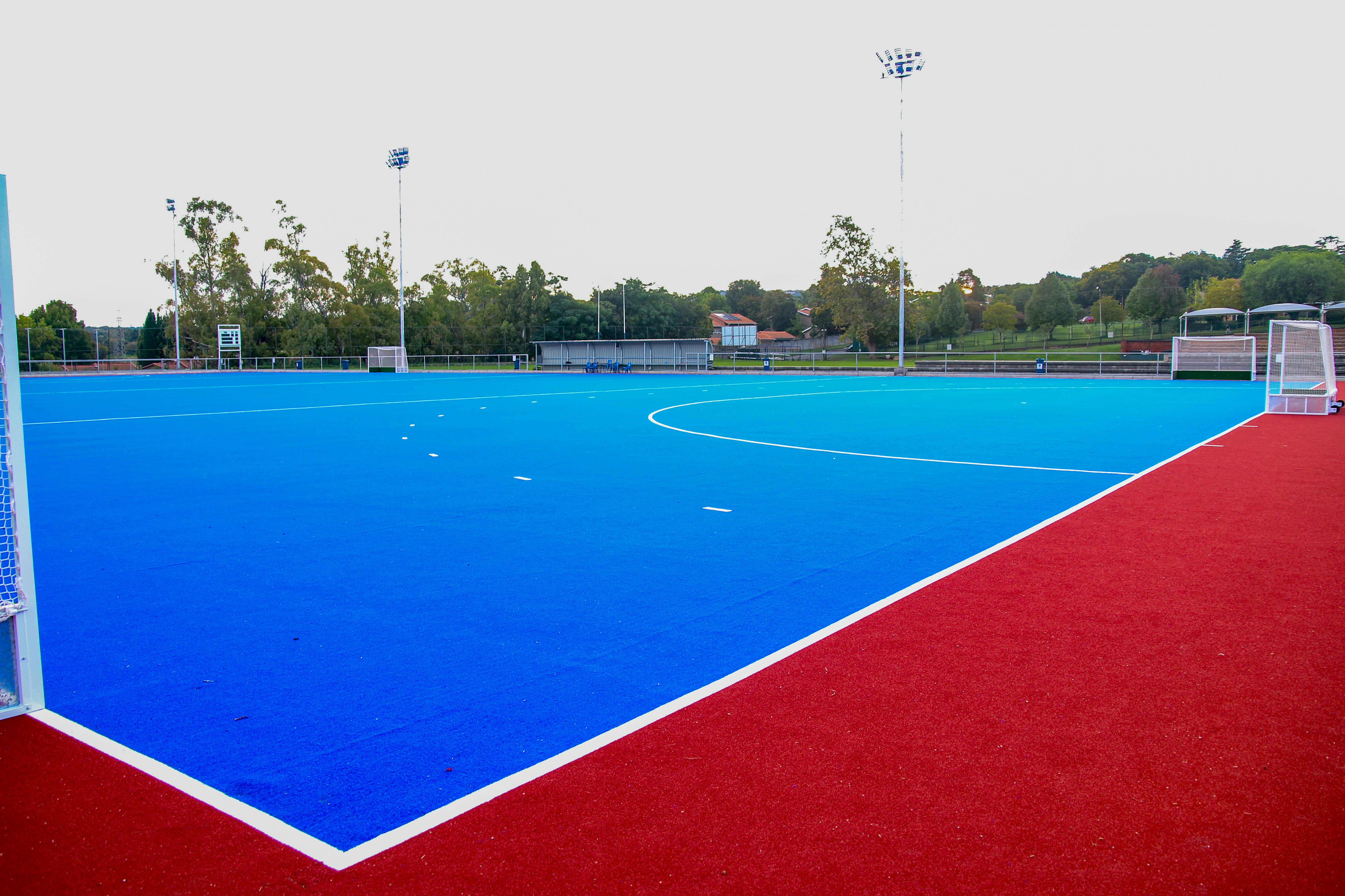 Blue Field Awash in Evening Light: Croquet-Style Court Meets Open Sky