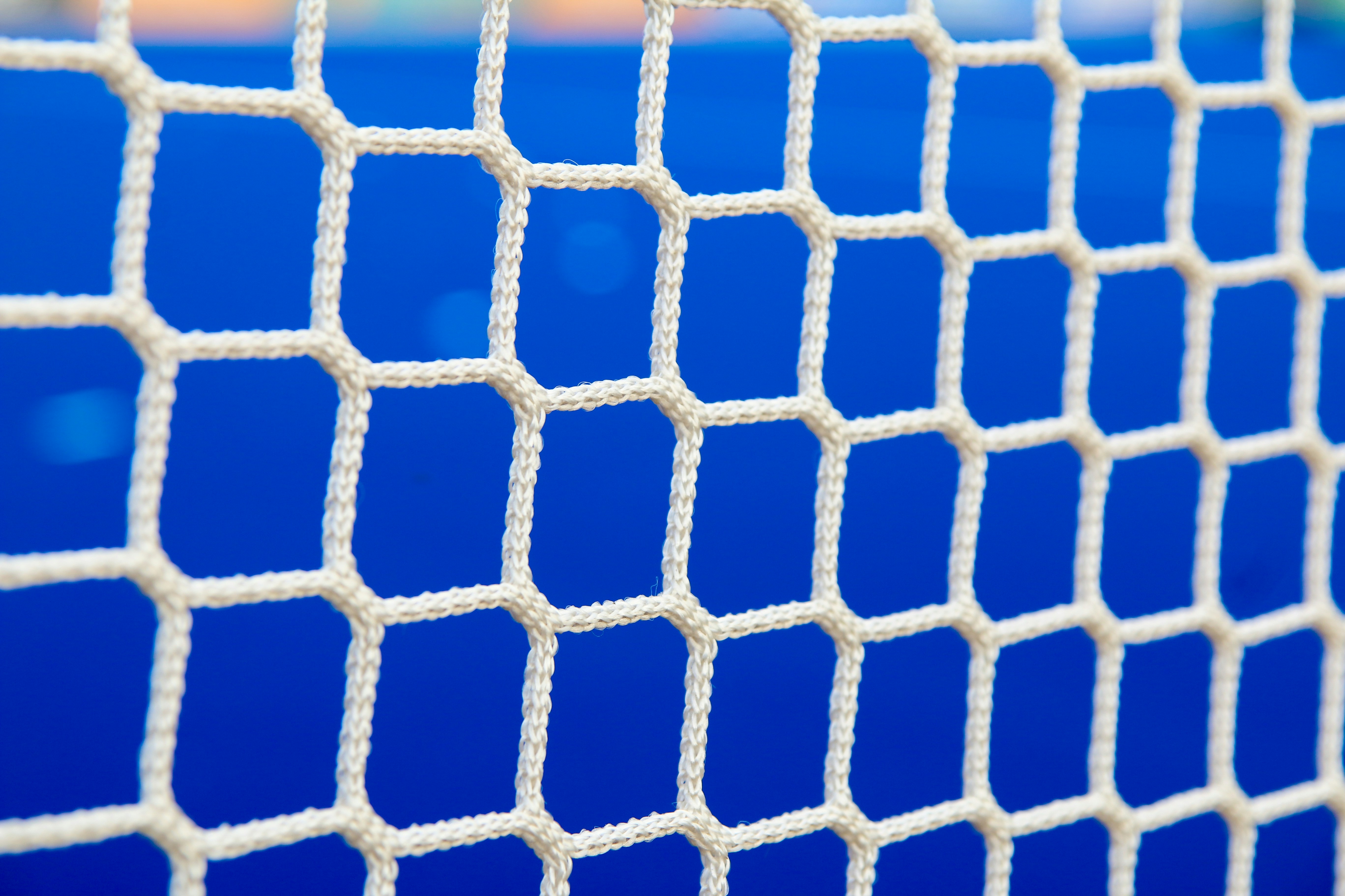 Tight Weave: A Close-Up of Netting Against a Deep Blue Backdrop