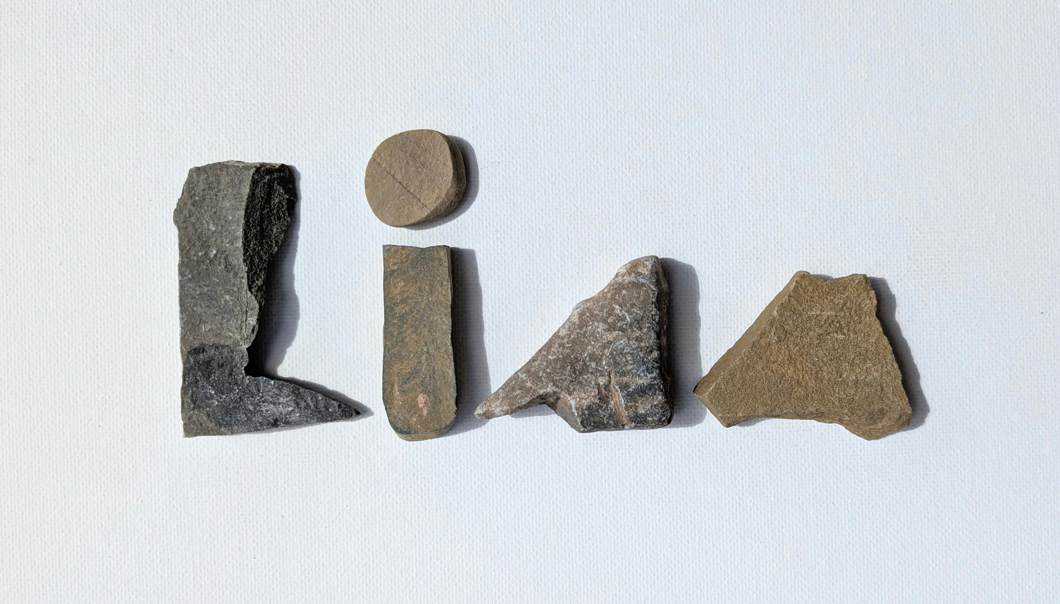 An arrangement of naturally fractured stones (found in Kananaskis, Alberta) spelling out a name.