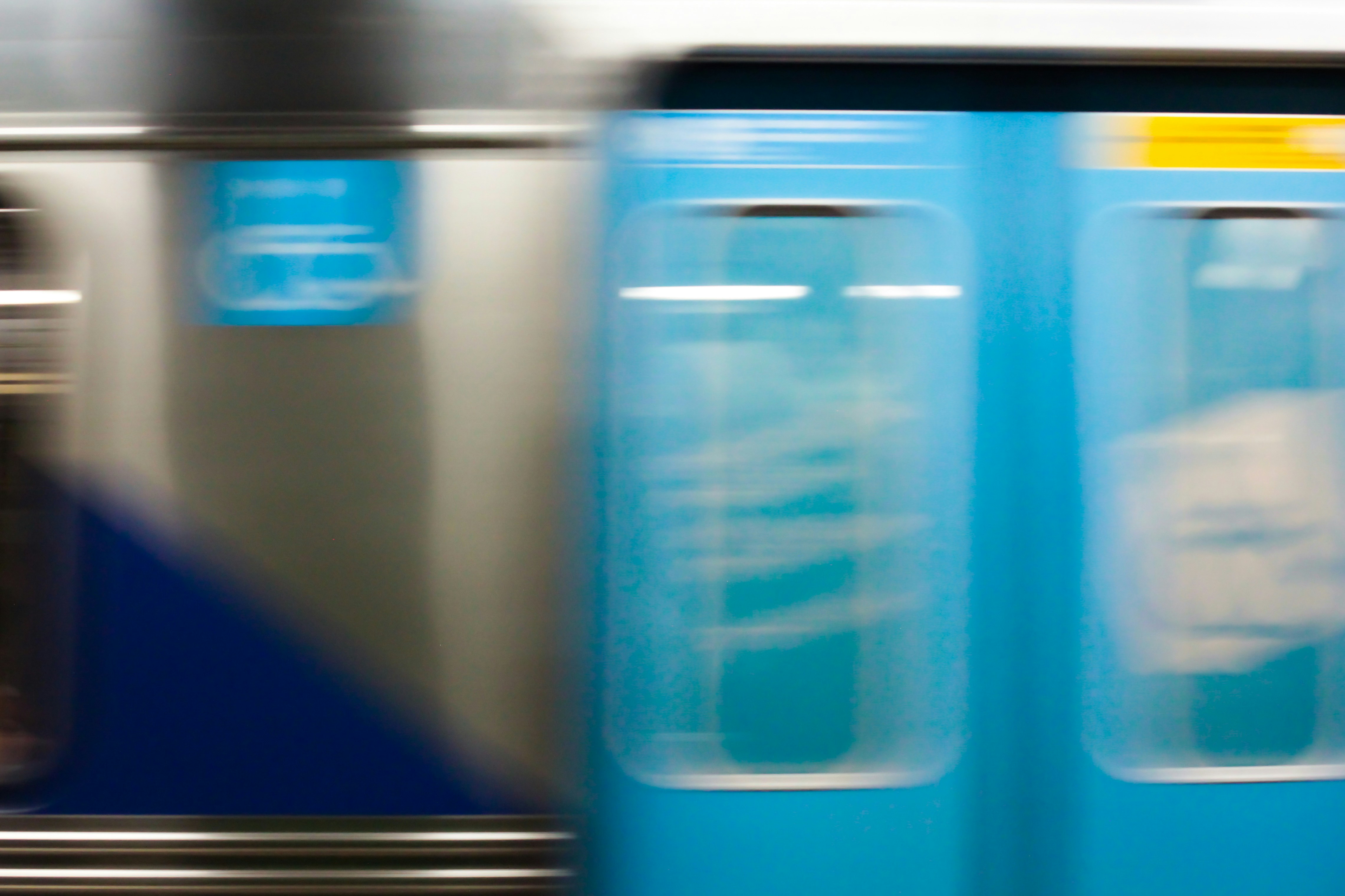 Blurred Transit: Blue Carriages in Motion