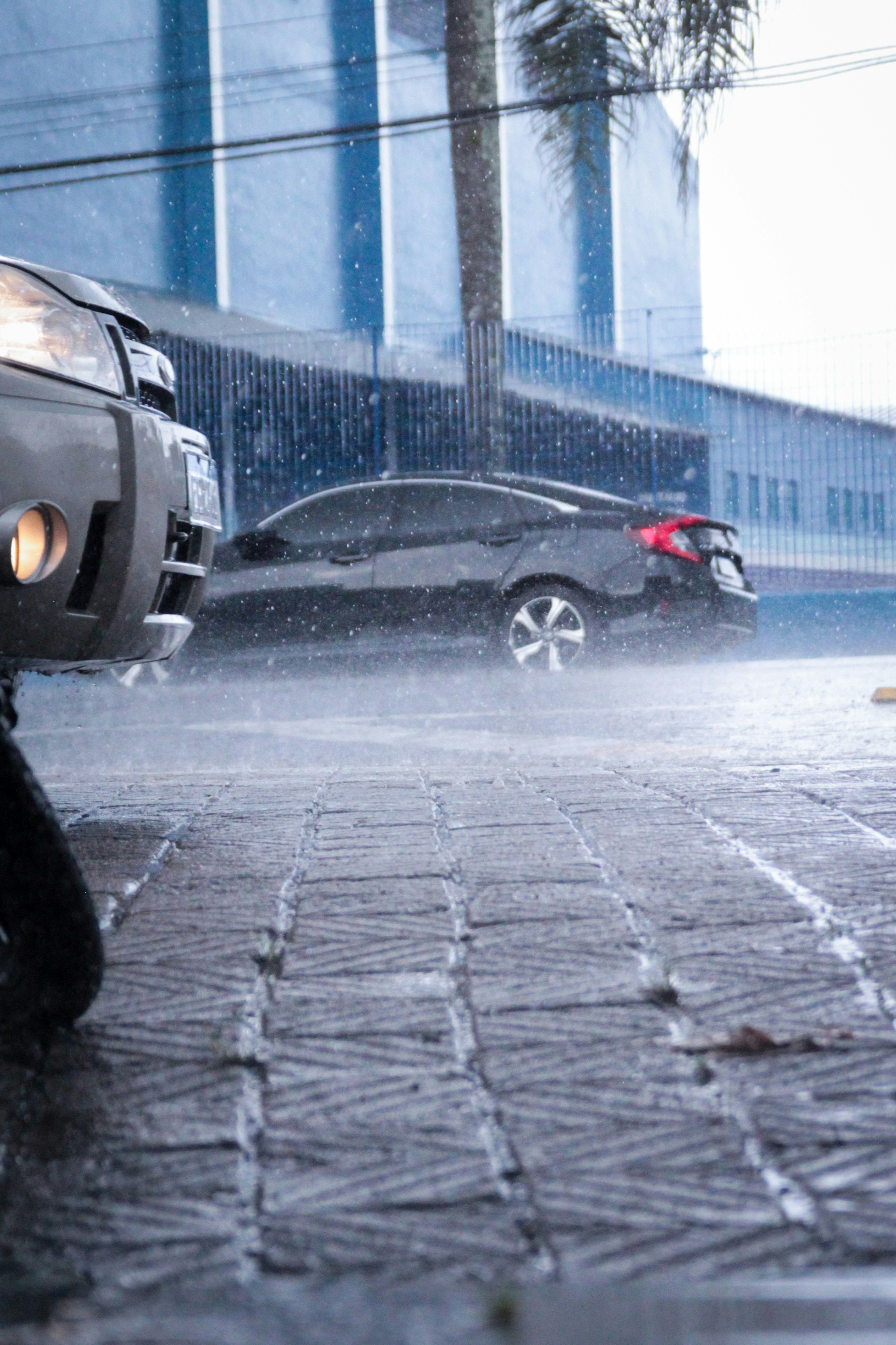 Low-Angle Winter Road: Cars in a Wet Street Scene
