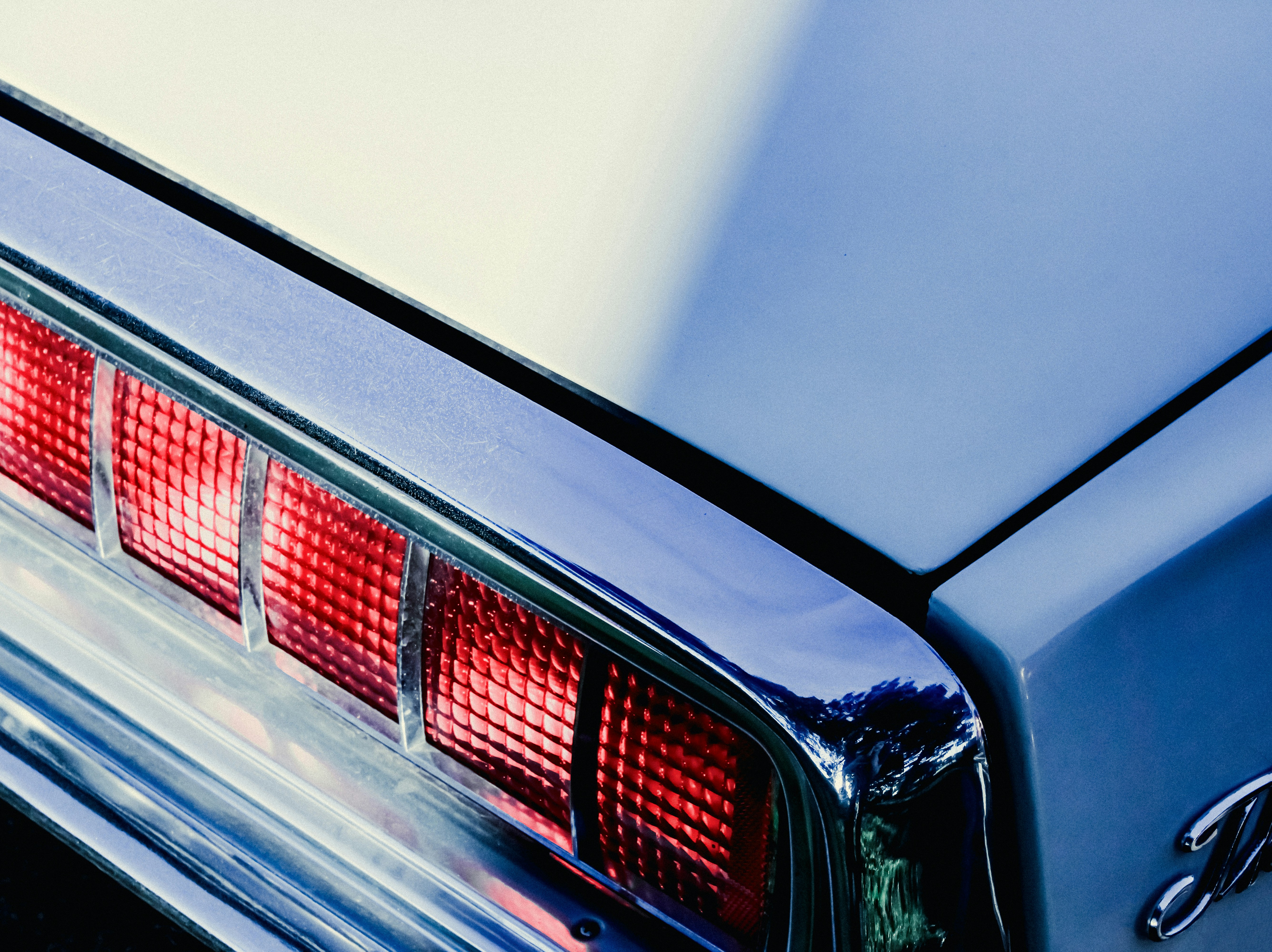 Rear Ridge: The Blue Car's Tail Lights and Curves