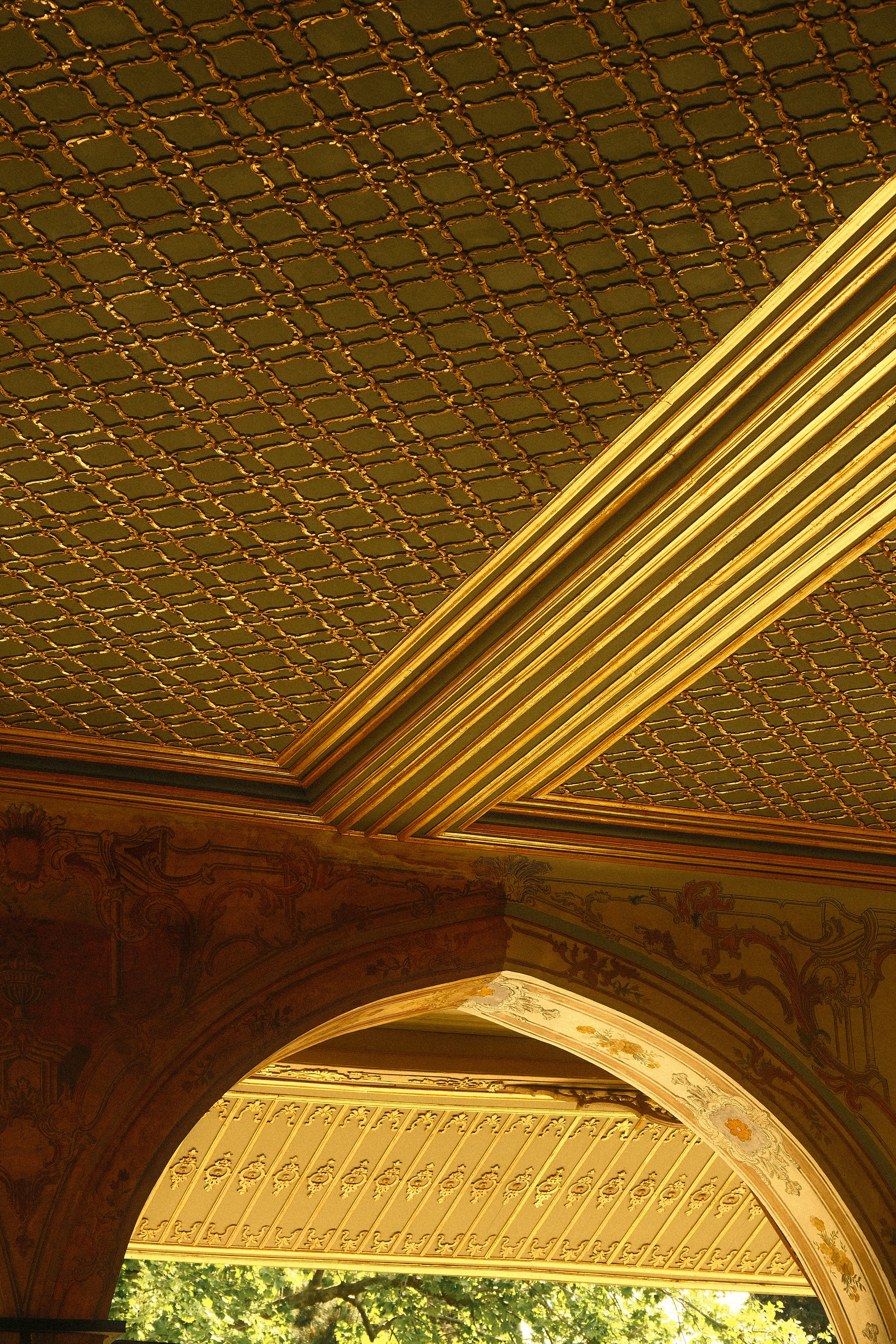 Golden Lattice: Architectural Ceilings and Archway in Warm Light